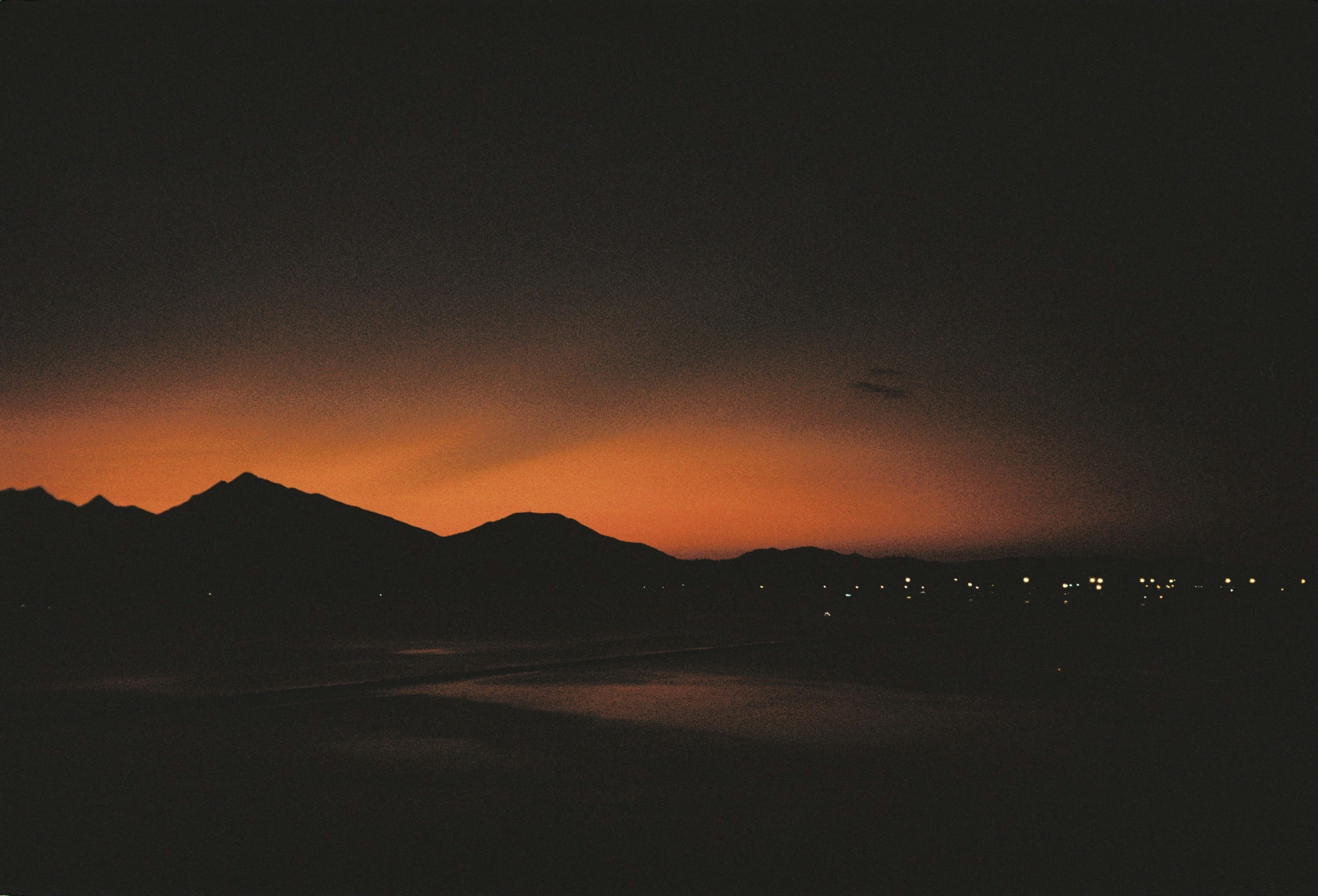 Evening Glow Over Silhouetted Peaks