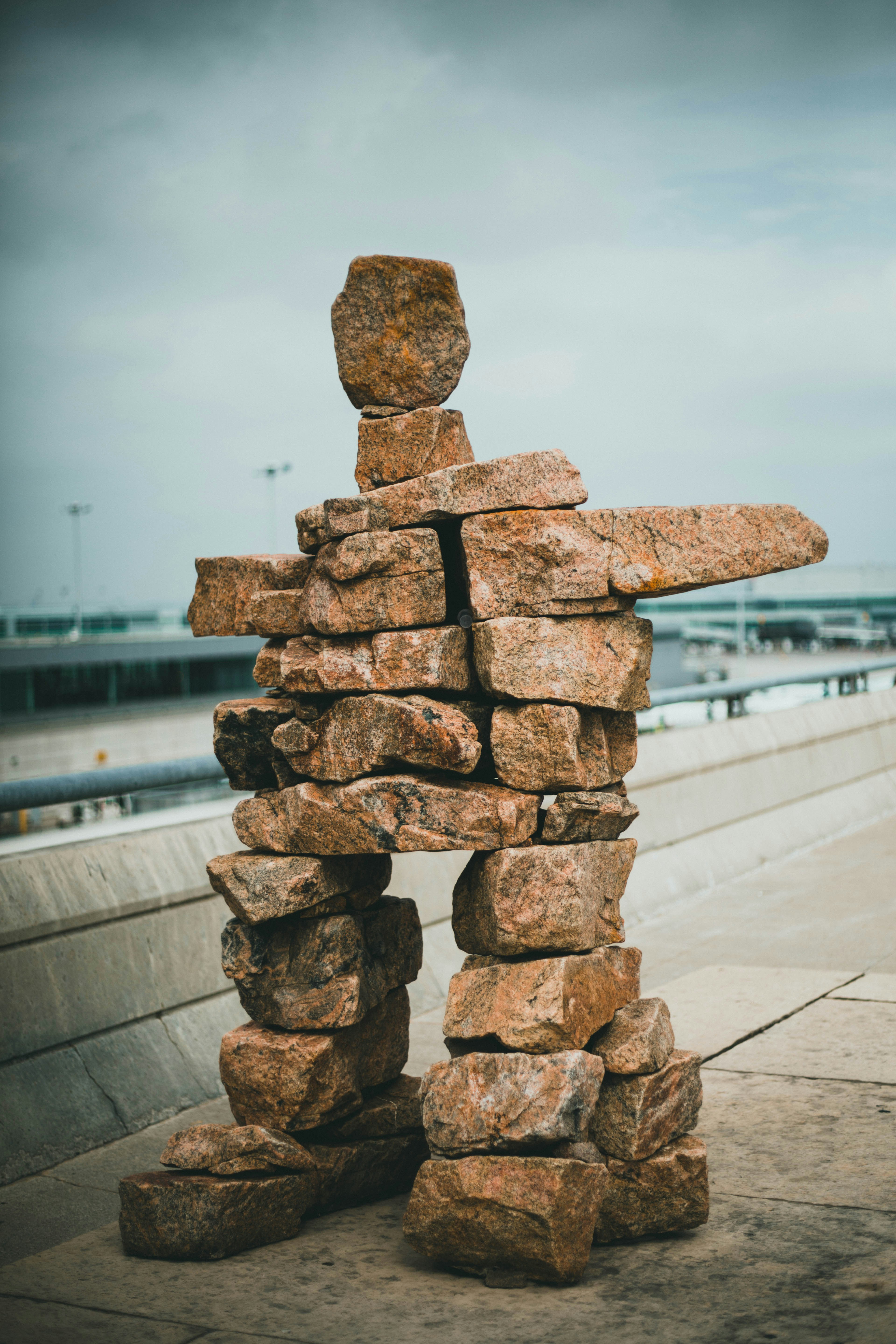 Cairn at the Quay: Quiet Balance Under an Overcast Sky