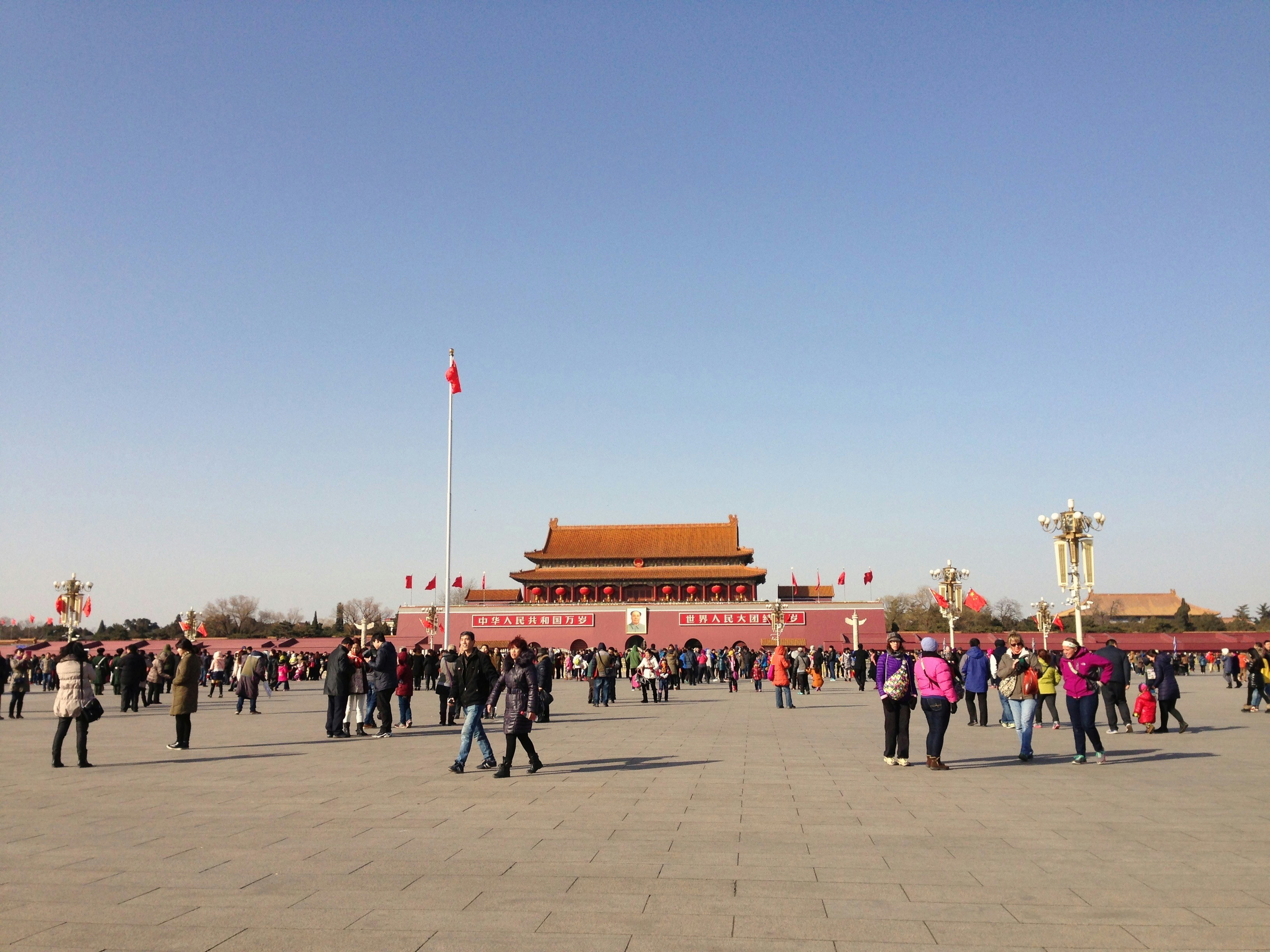 Beijing's Gate of Heavenly Peace: symmetry, crowds, and a rising flag on a sunlit plaza