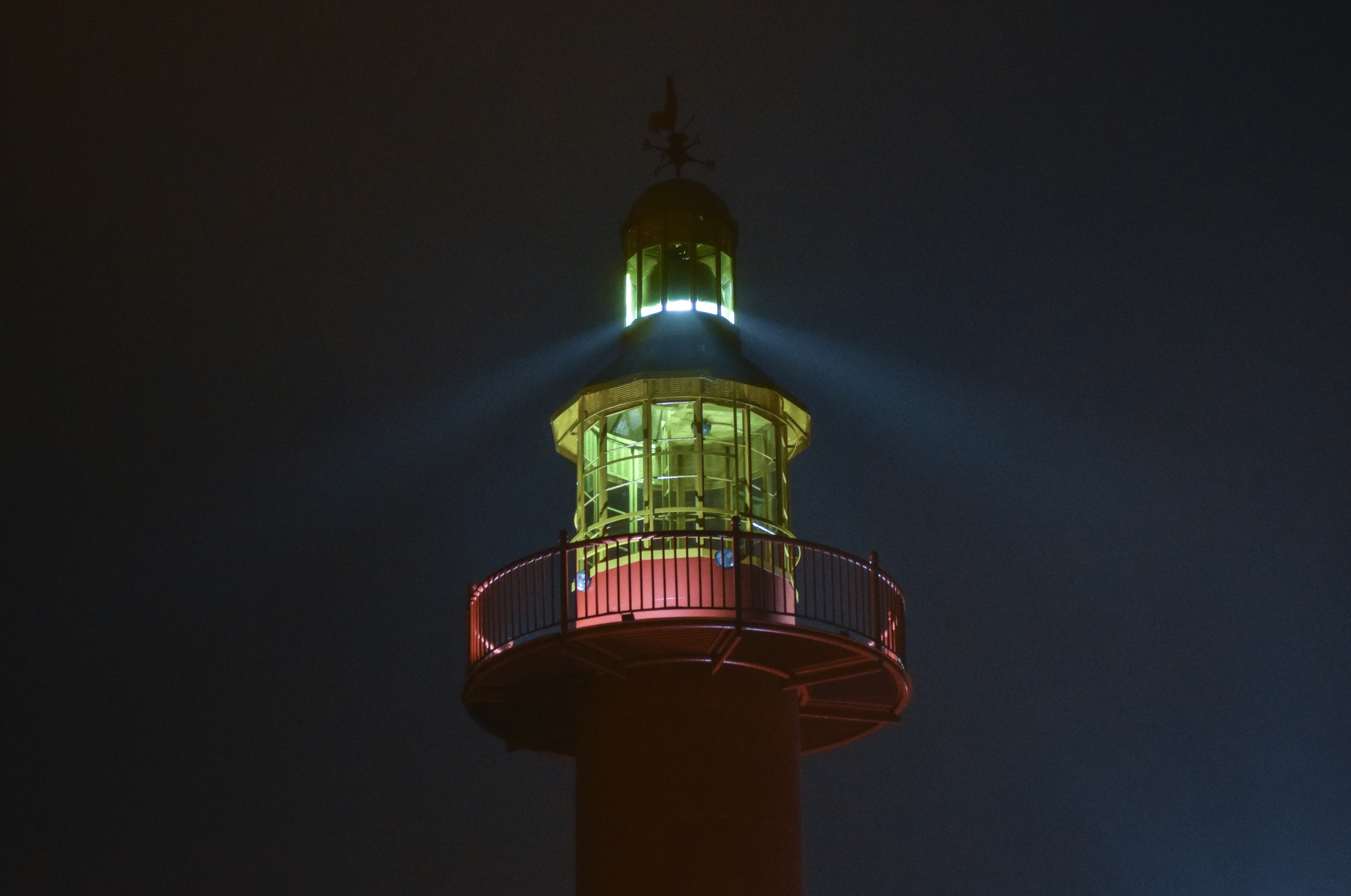 Night Beacon: The Lighthouse's Blue Sweep from a Lantern Above