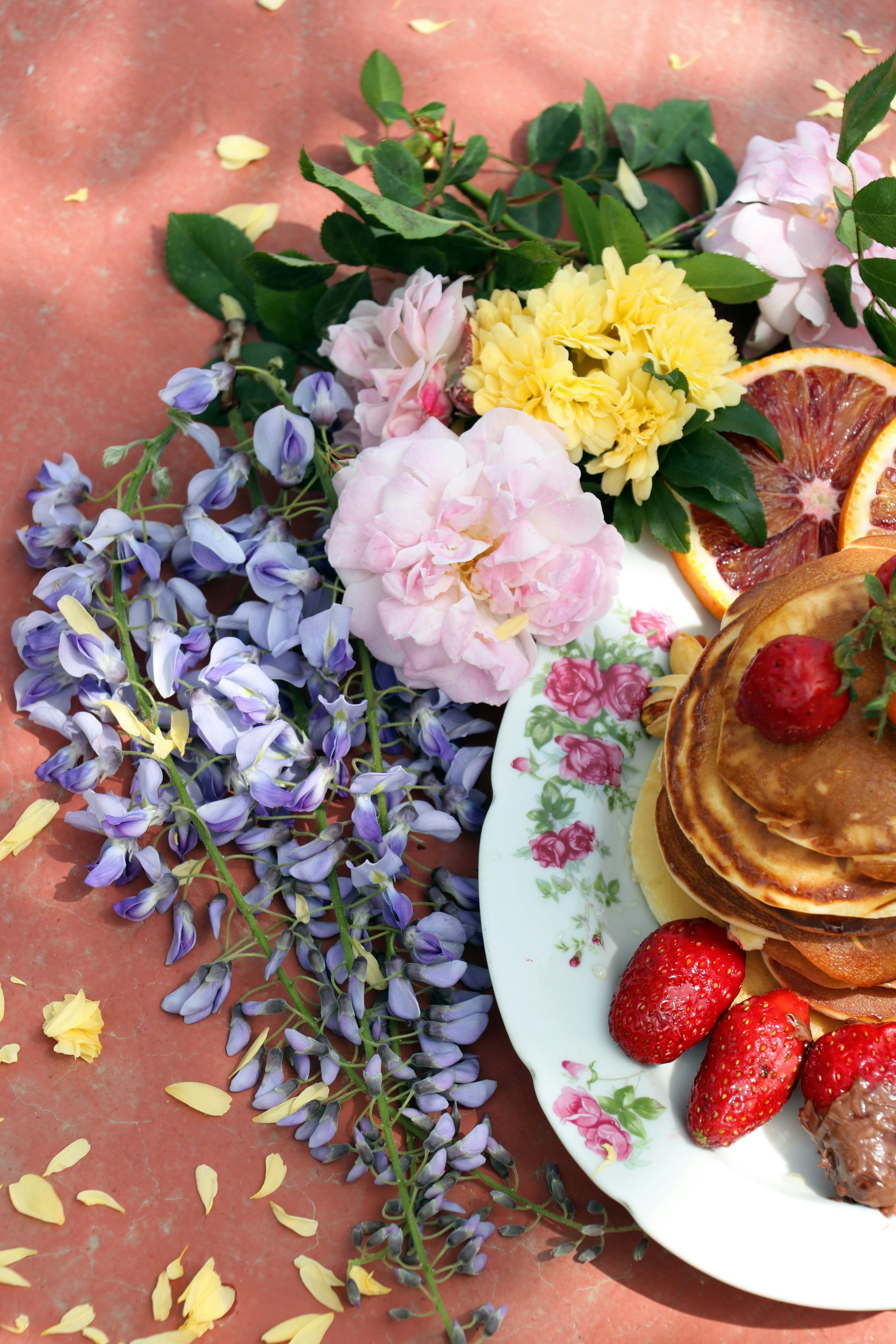 A plate of pancakes, strawberries, and flowers on a table photo – Free ...