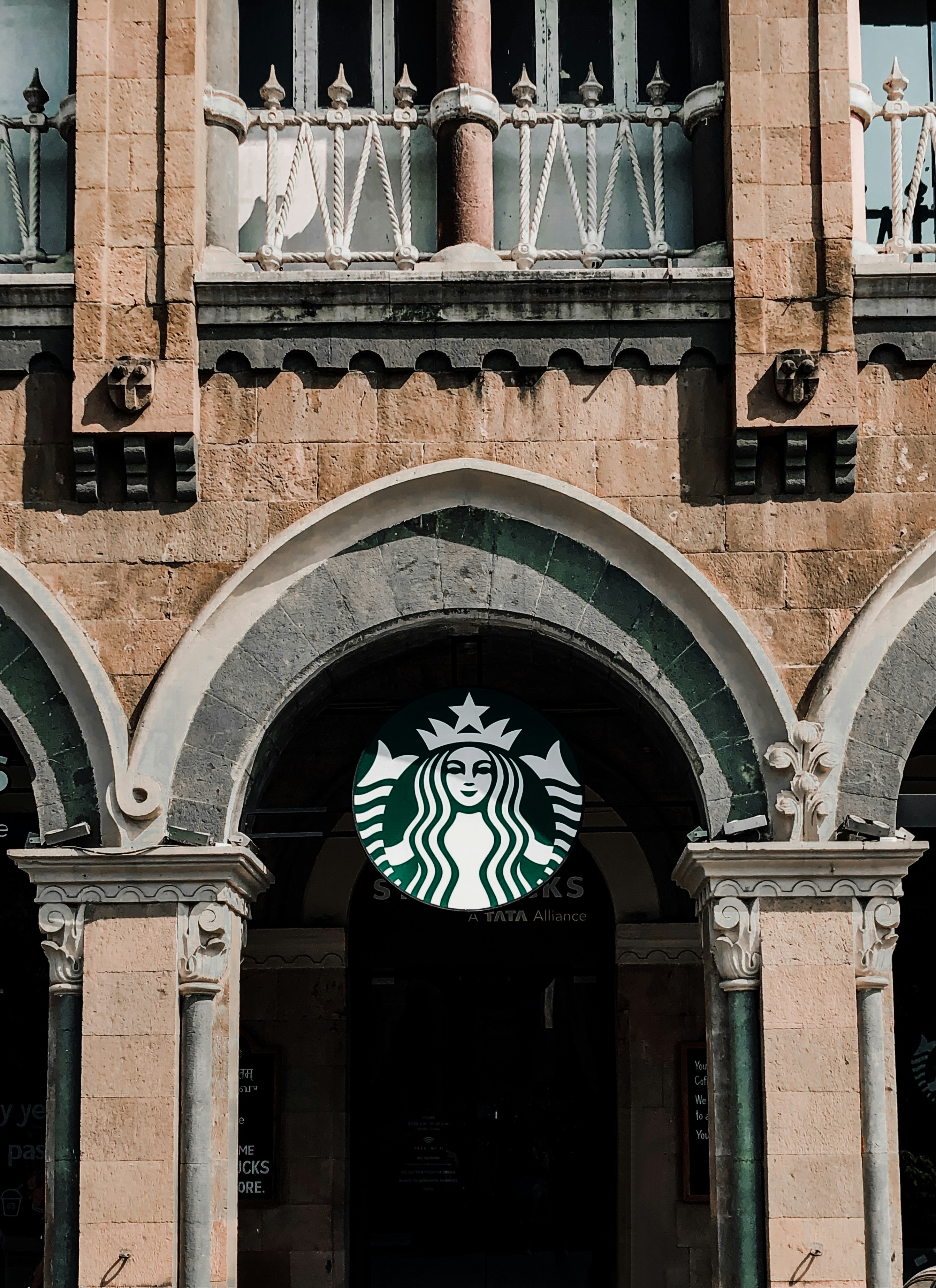 Starbucks Crest Framed by Venetian-Style Arches in Weathered Stone