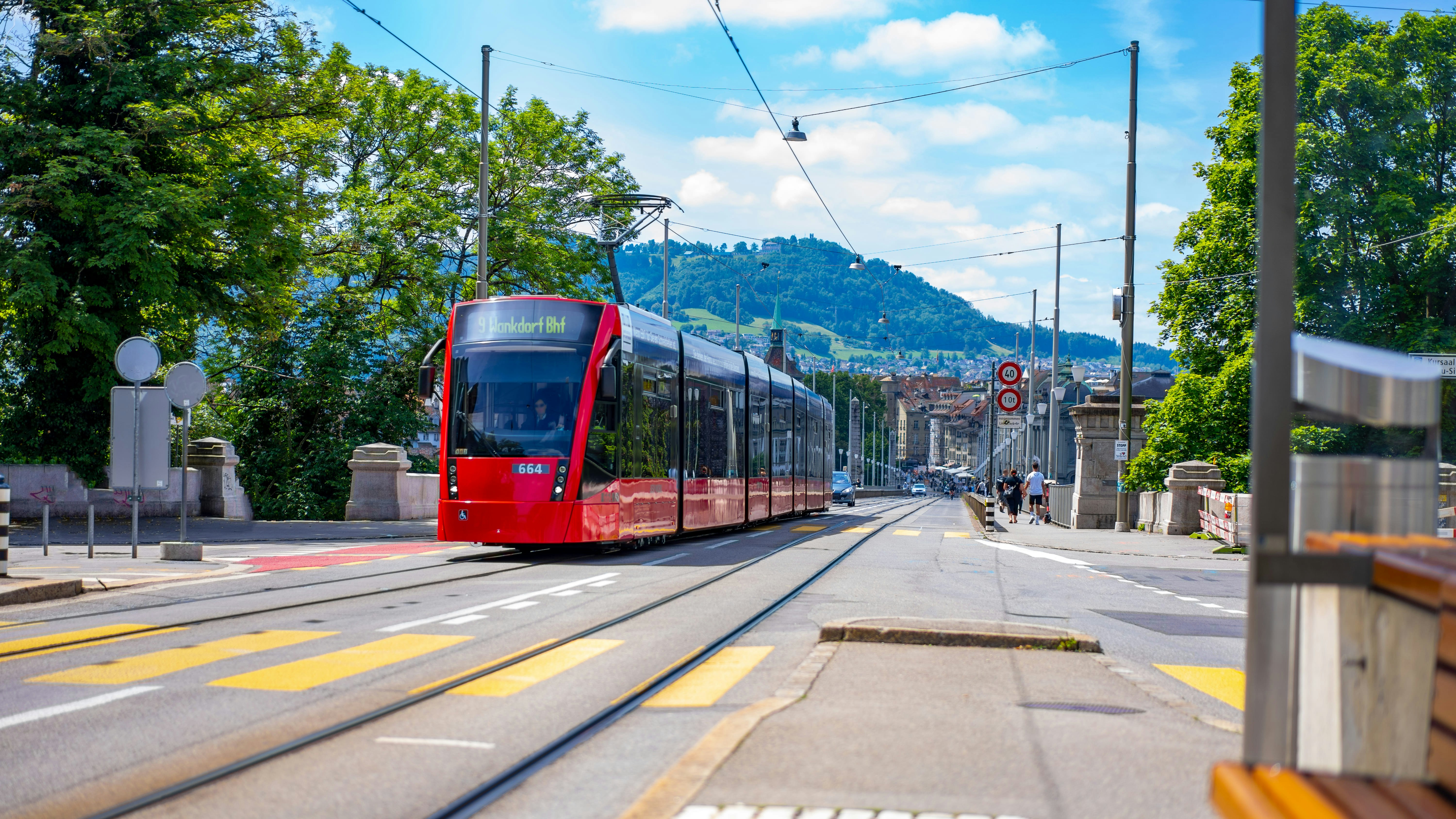 Red and white train on rail road during daytime photo – Free Bern Image ...