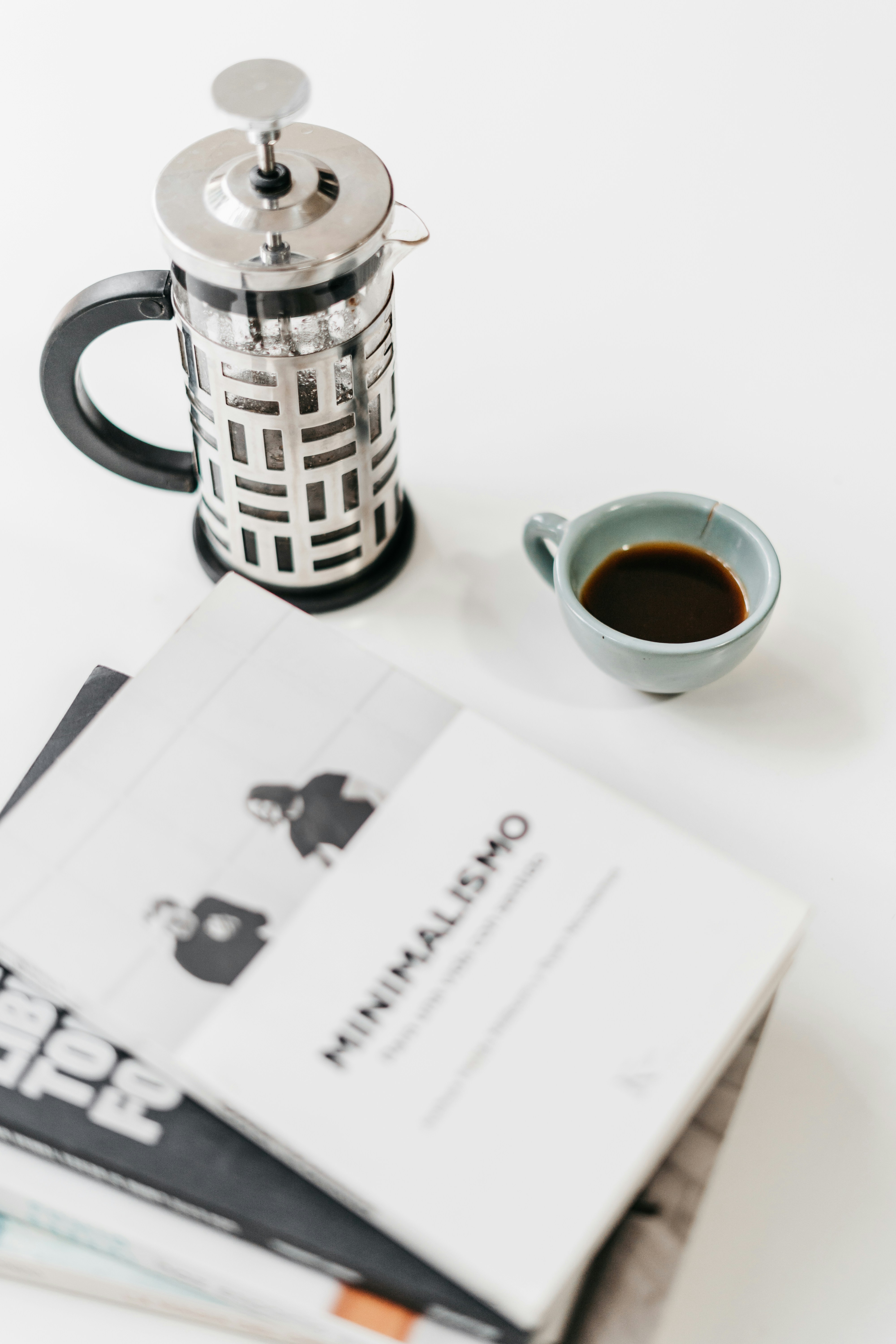 Stainless Silence: A Moka Pot, Black Coffee, and Minimalist Paper Stacks