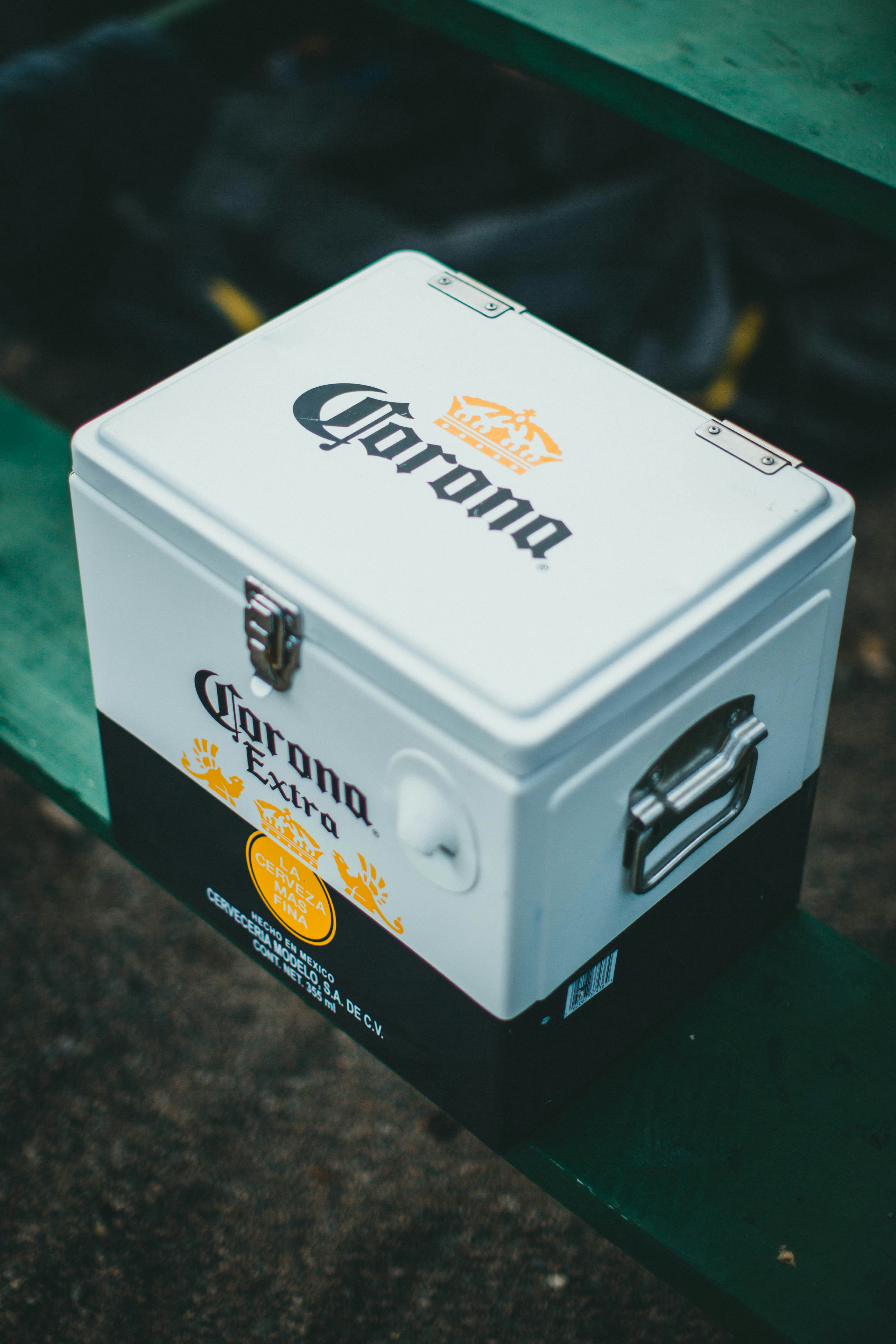 Corona Cooler on a Bench: Branded Metal Box with Bold Logos