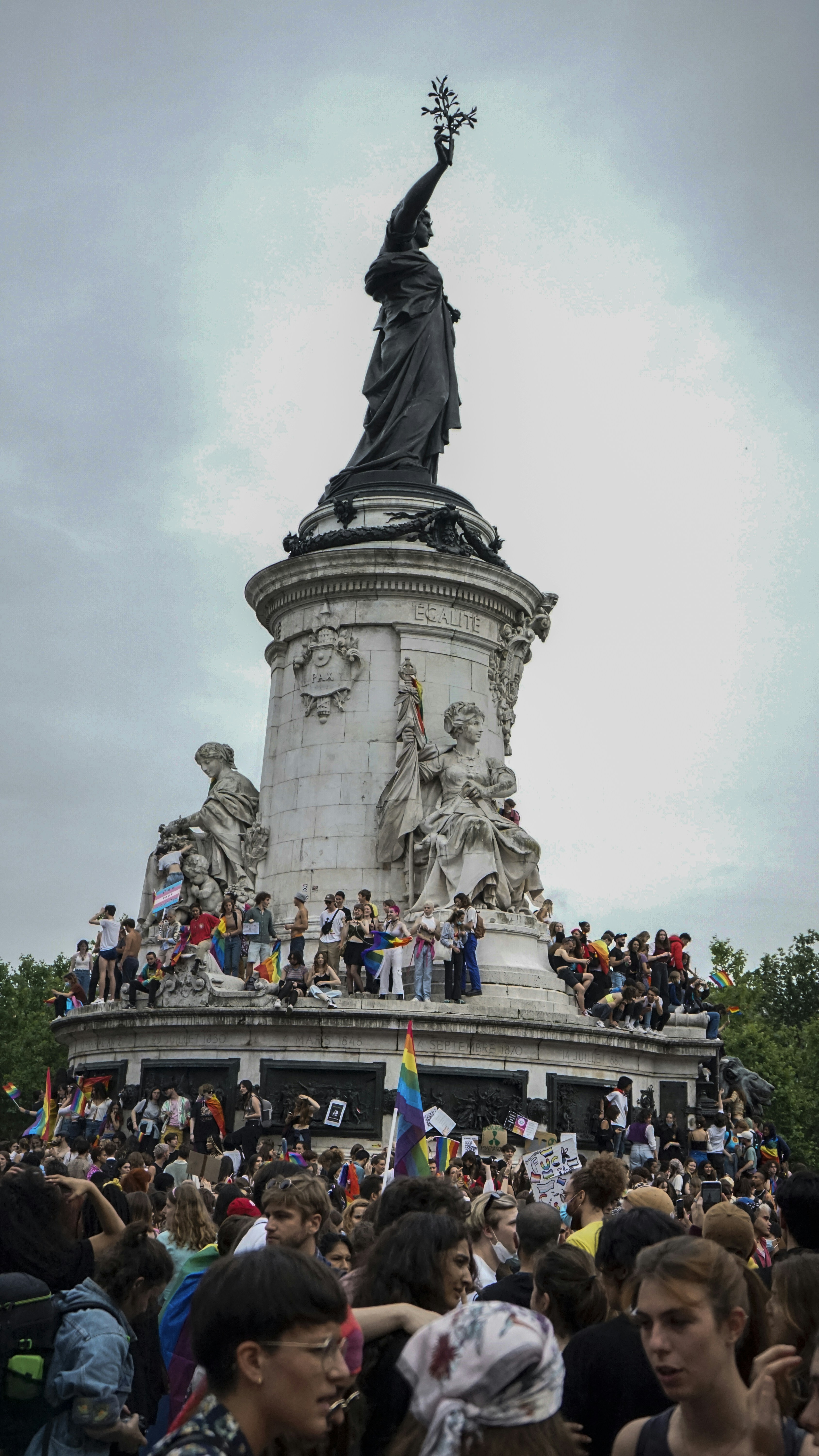People standing on gray concrete statue under white clouds during ...