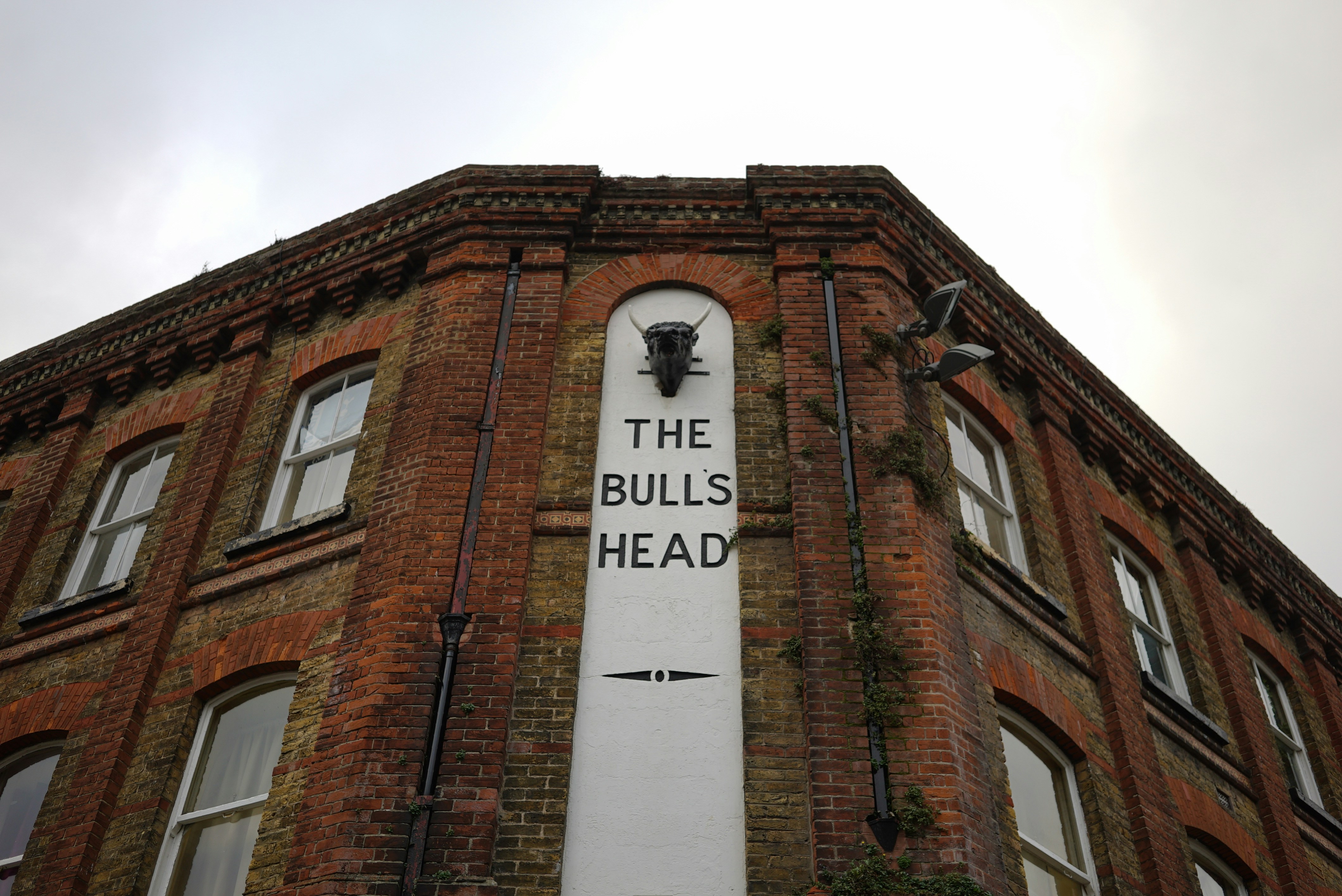 The Bull’s Head Sign on a Weathered Brick Corner