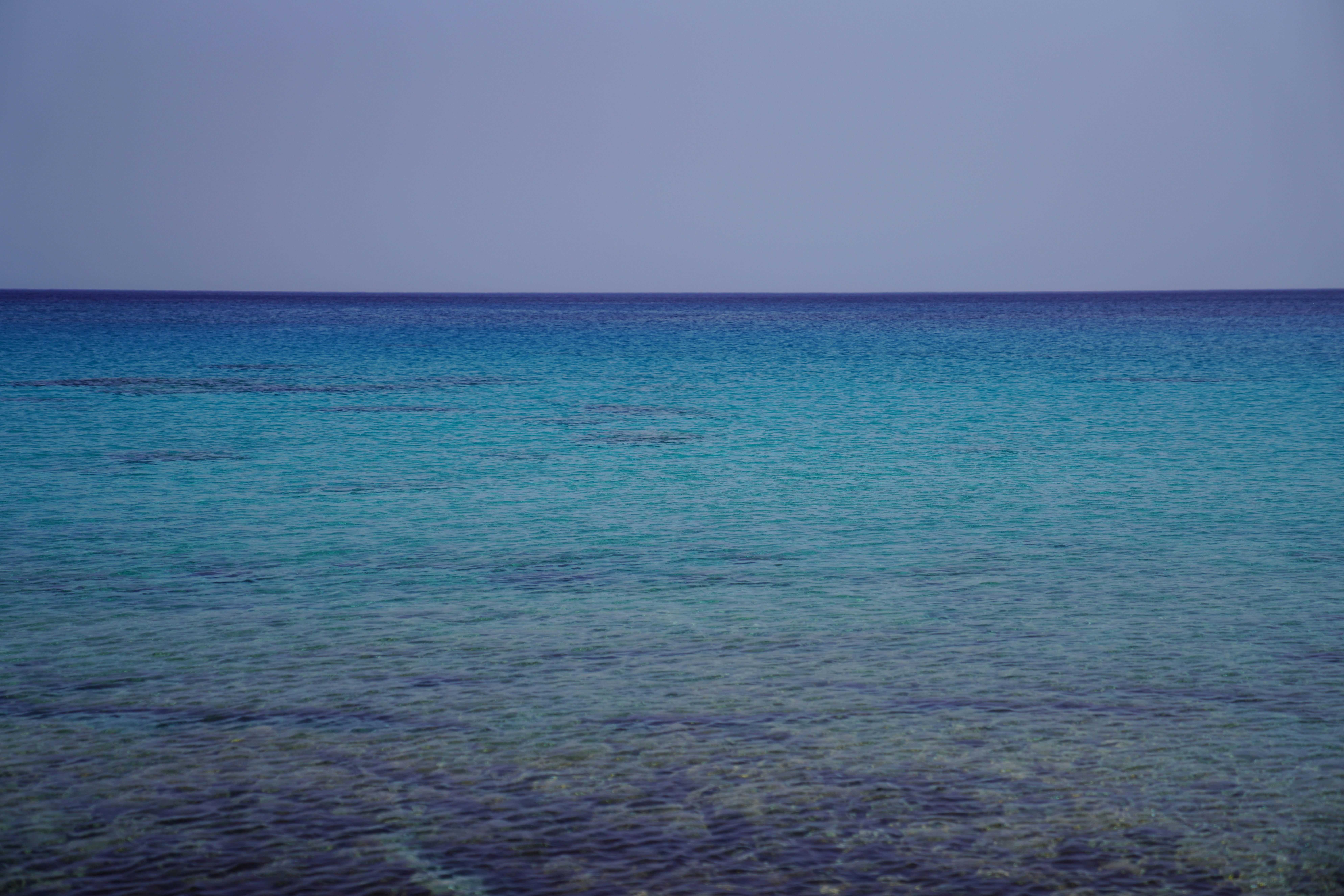 blue sea under blue sky during daytime