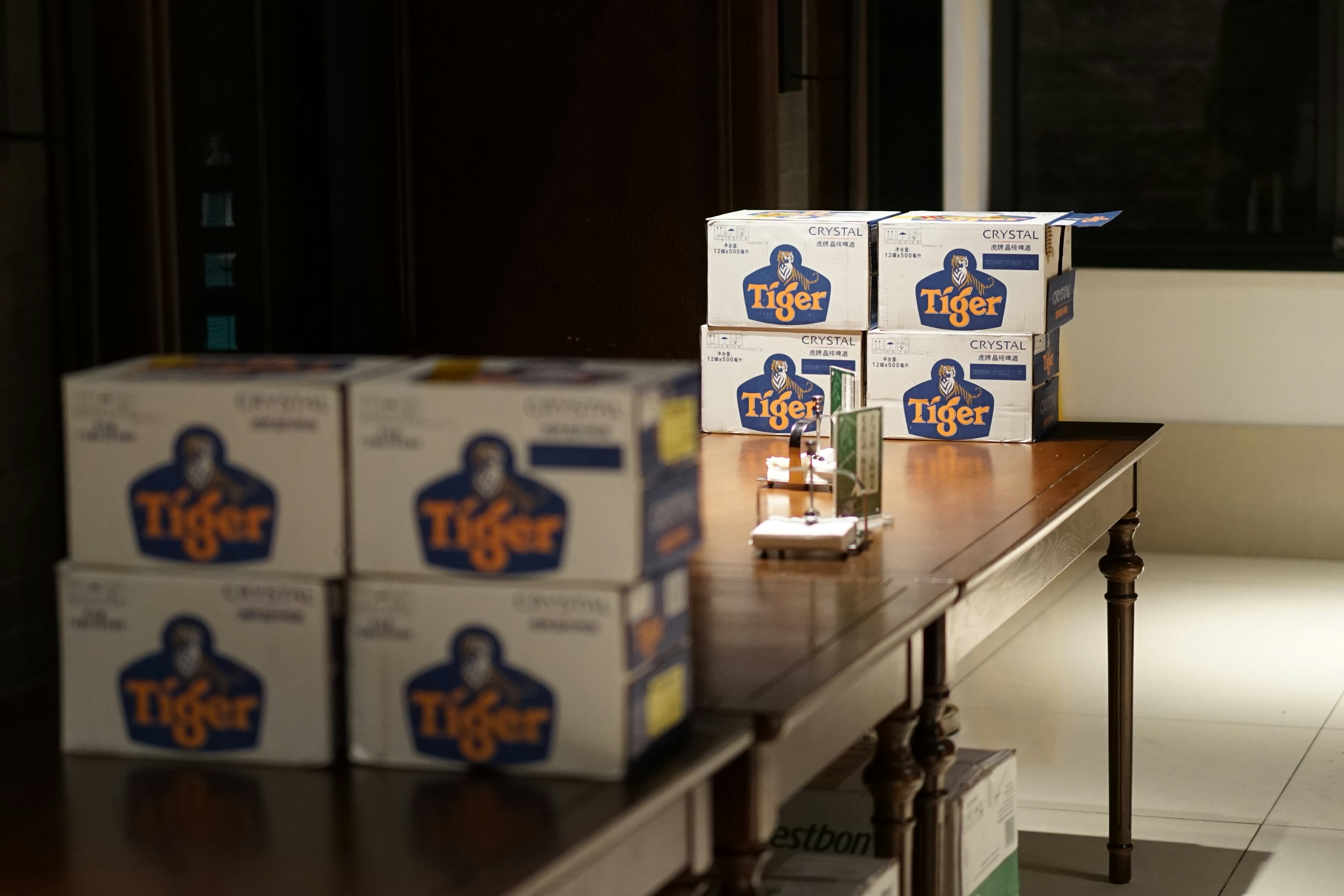Tiger Boxes and a Tiny Gadget: A Quiet Still-Life on a Wooden Table