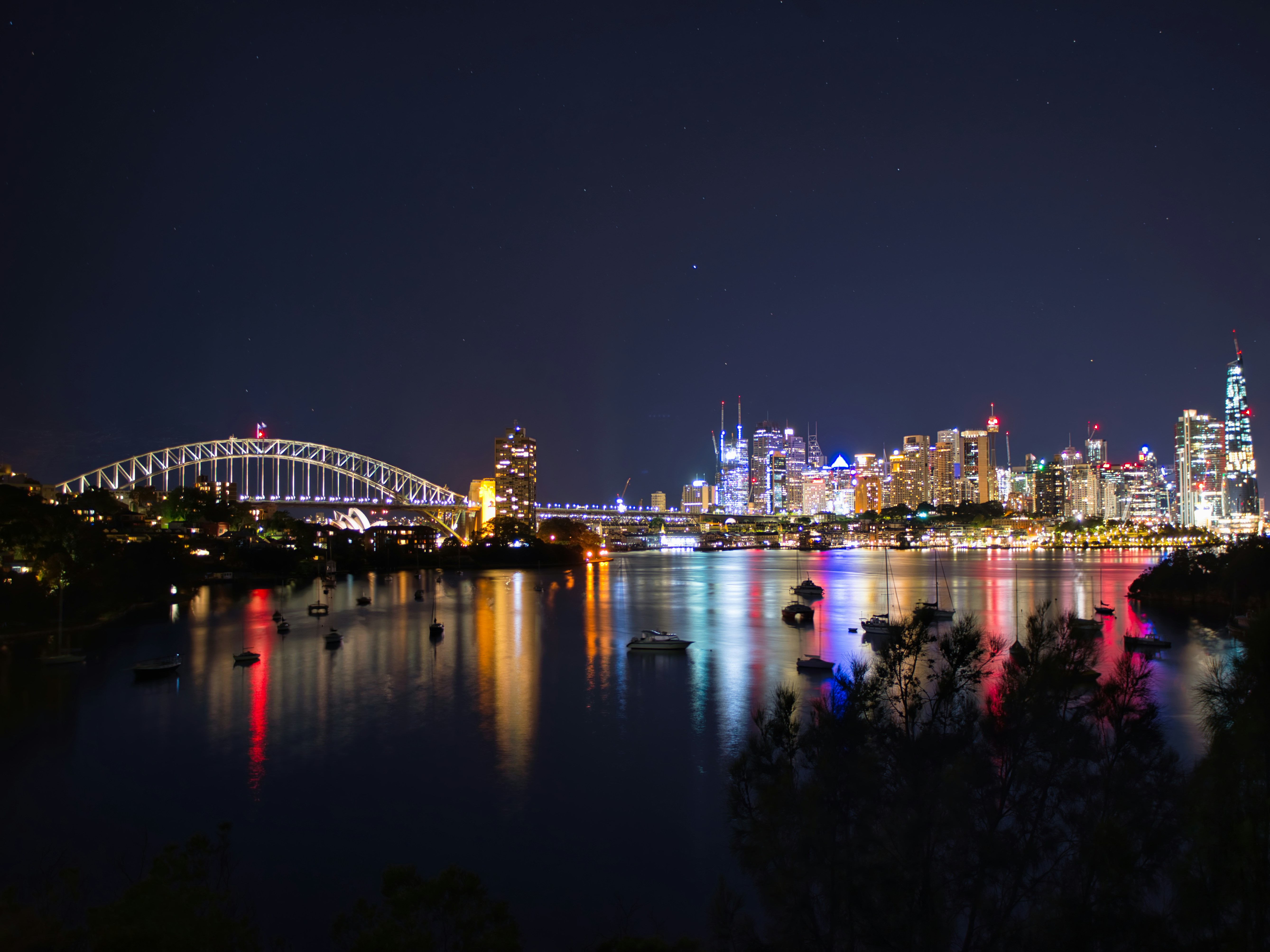 Harbor Lights: Arch Bridge Framing a Neon Cityscape