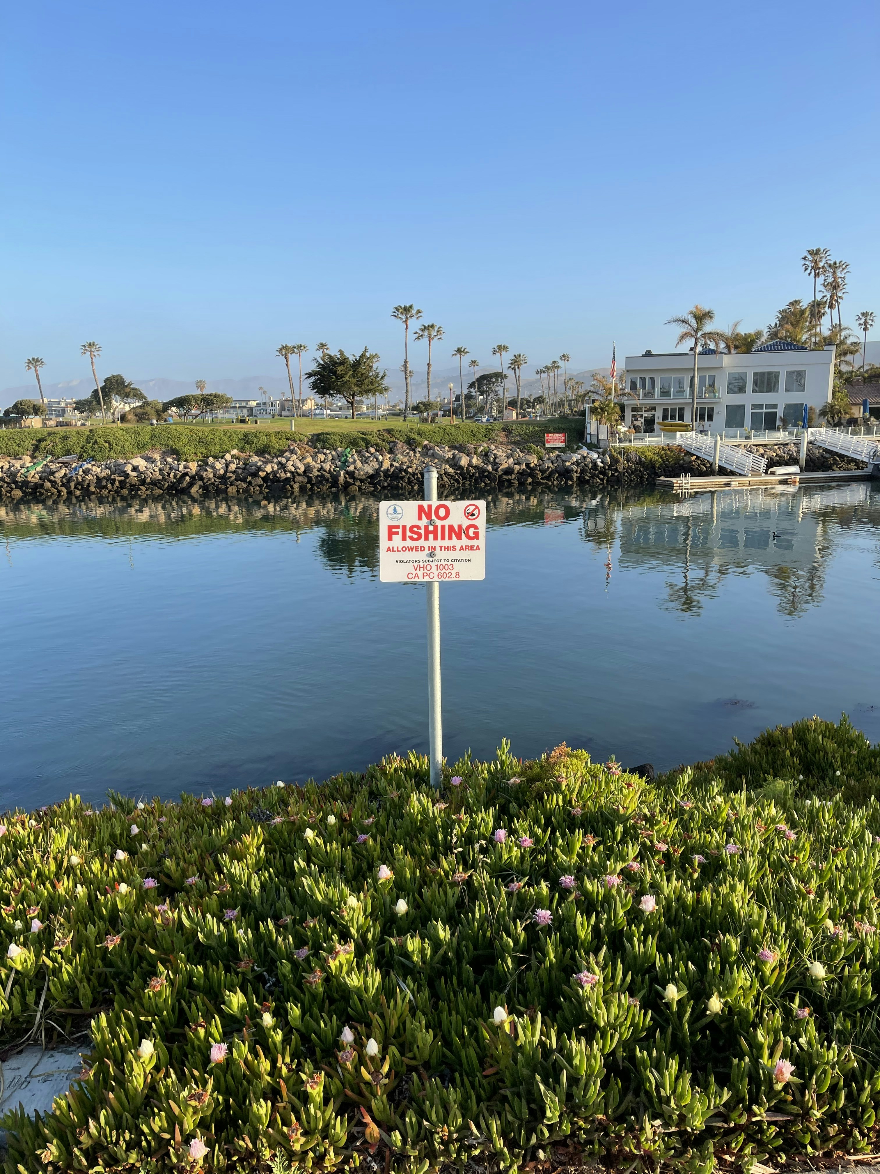 White and red signage near body of water during daytime photo – Free ...