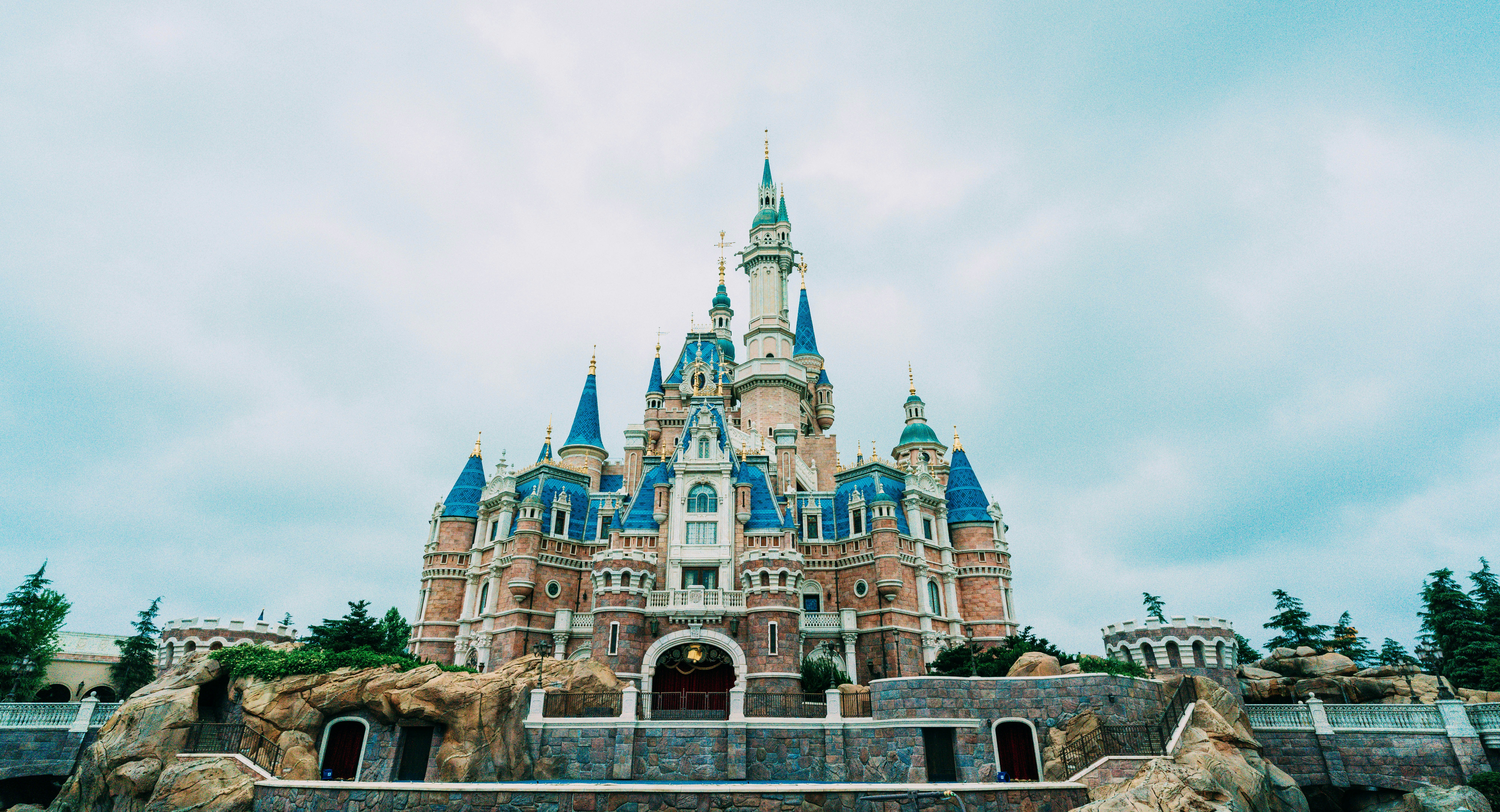 Blue and white concrete building under white clouds during daytime ...