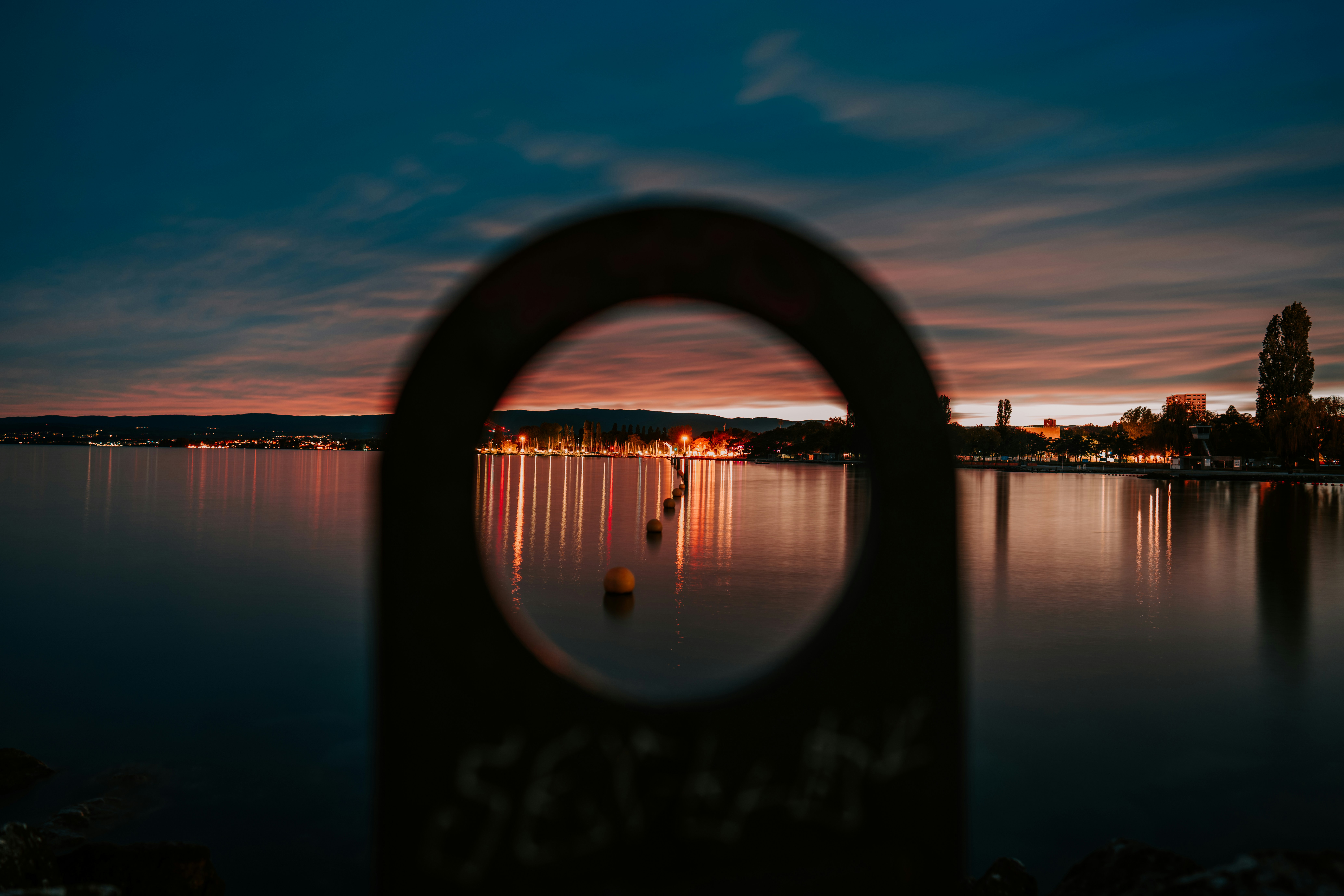 Circles of Dusk: Twilight harbor framed through a circular ring
