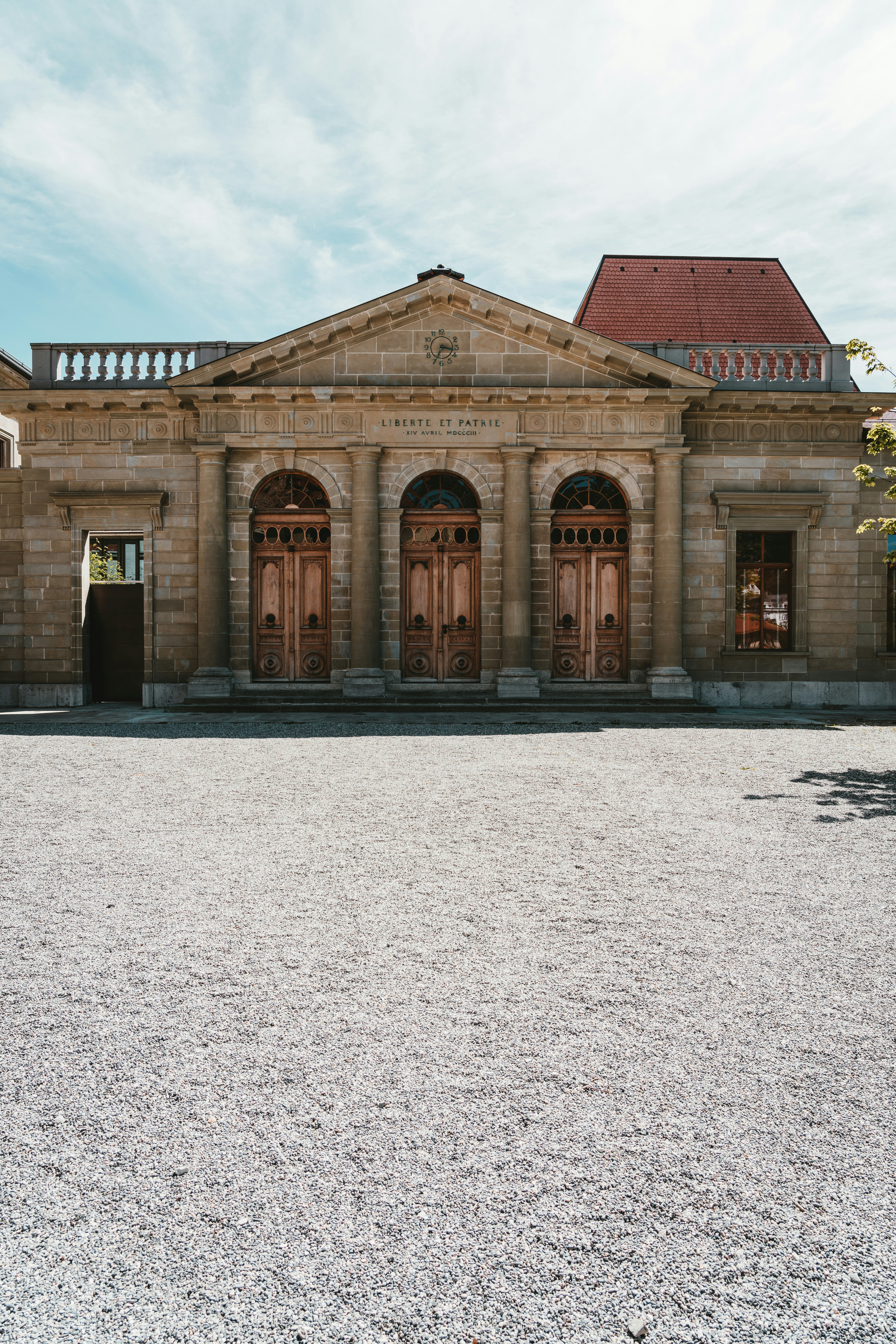 Three Arched Doors on a Sunlit Neoclassical Facade