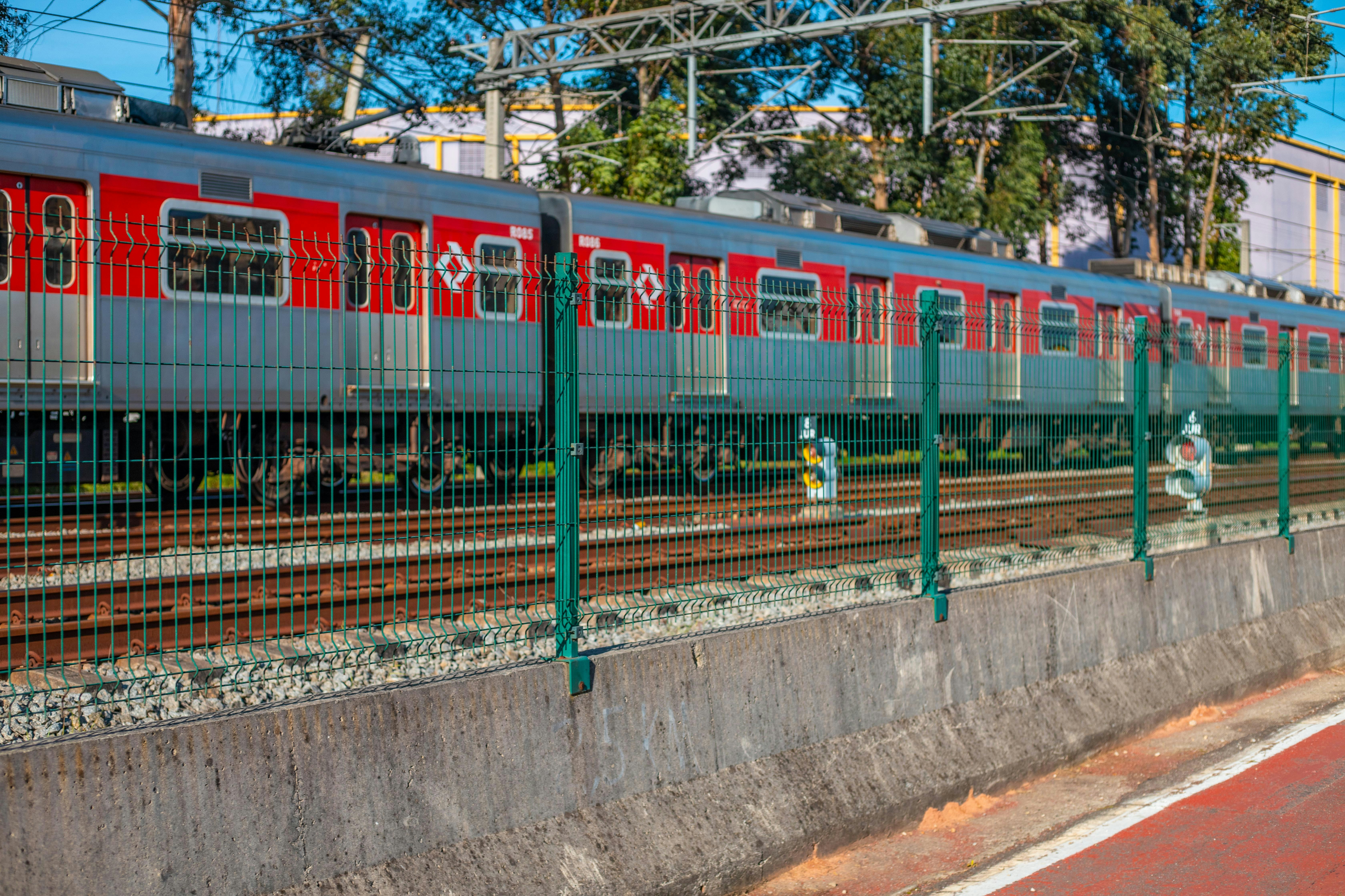 Red and green train on rail tracks during daytime photo – Free Cptm ...