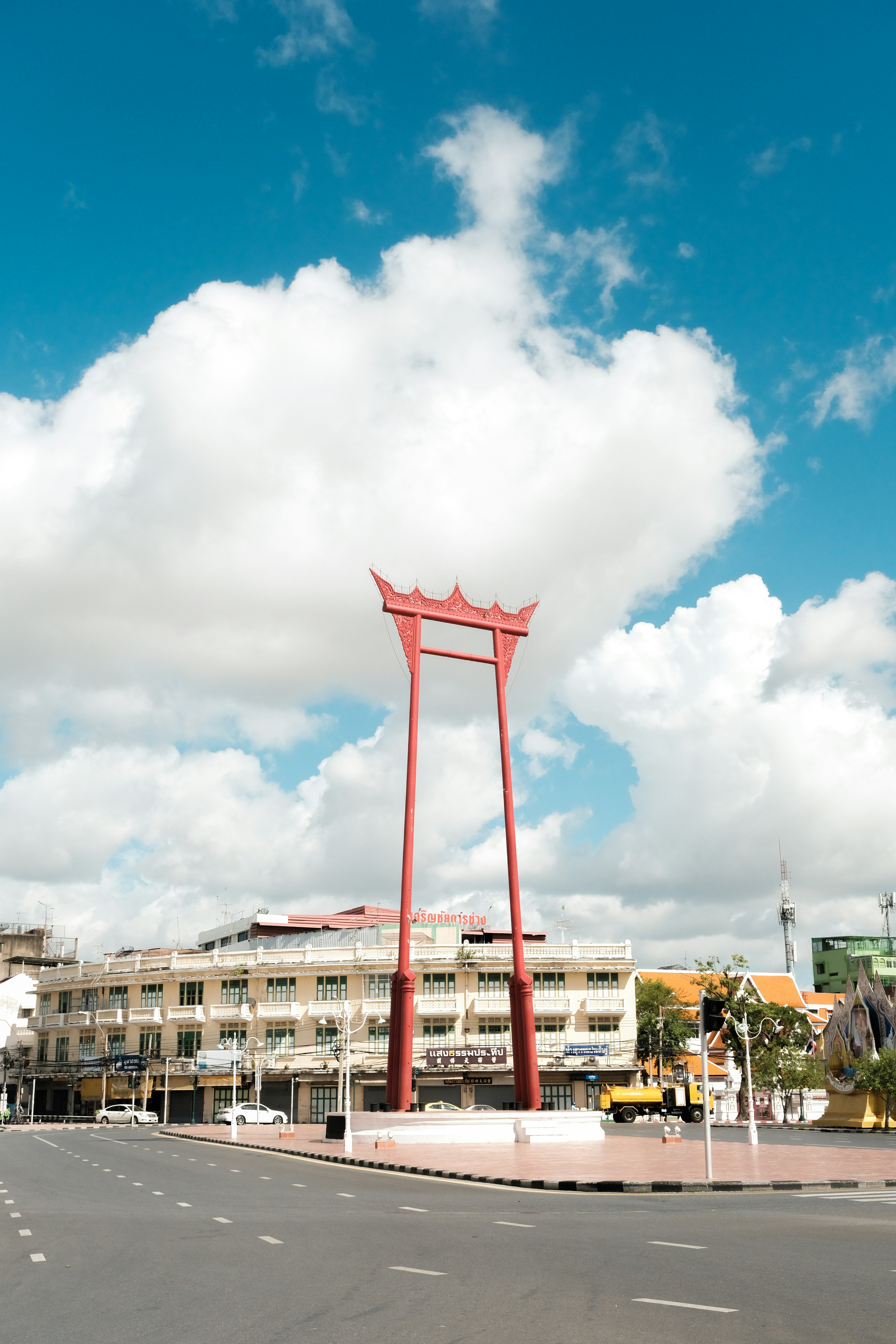 Crimson Gateway Over a Quiet City Square