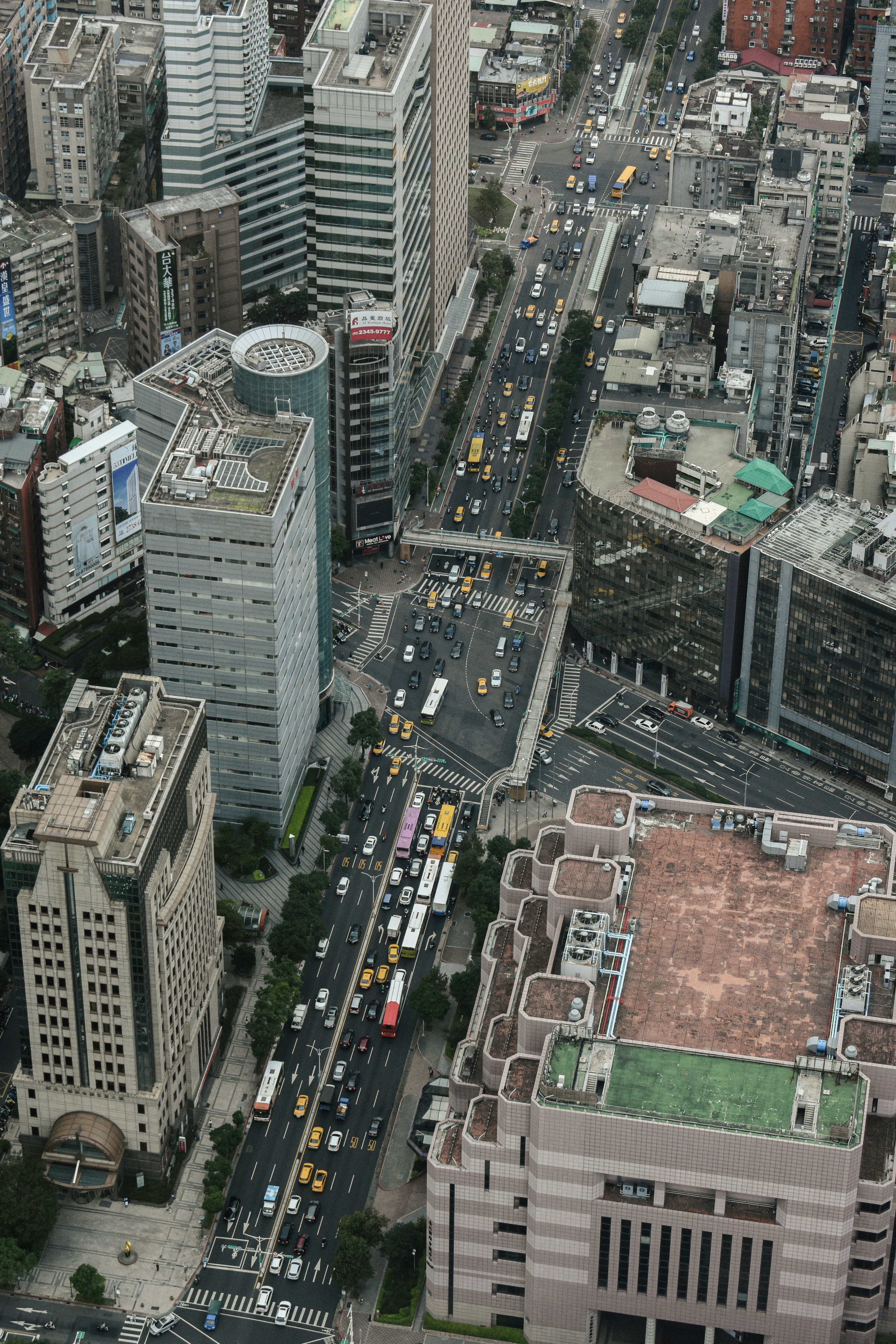 Vertical Pulse: Traffic Ribbons Woven Through a Glass Canyon