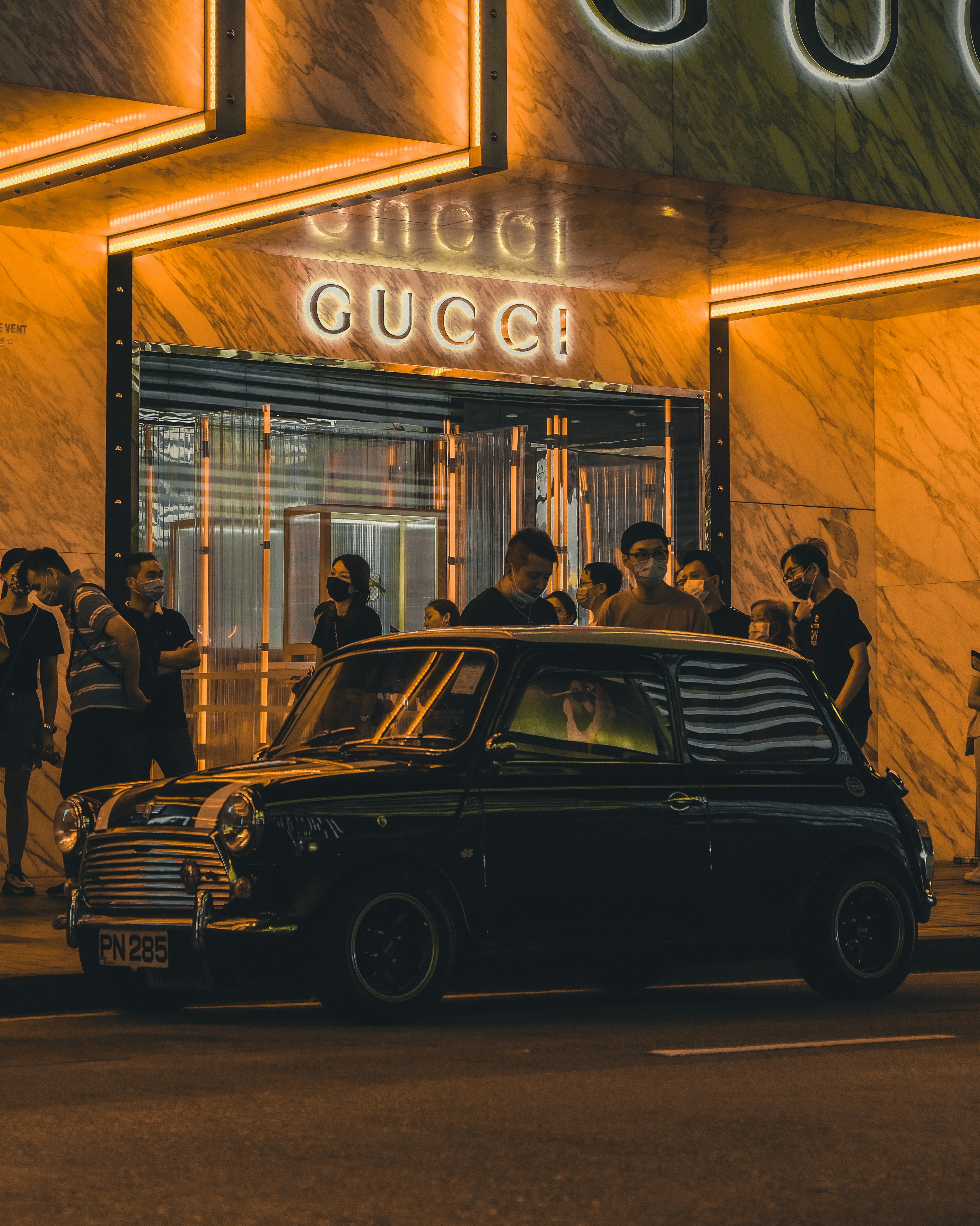 Neon Marble Night: A Vintage Car at Gucci's Entrance