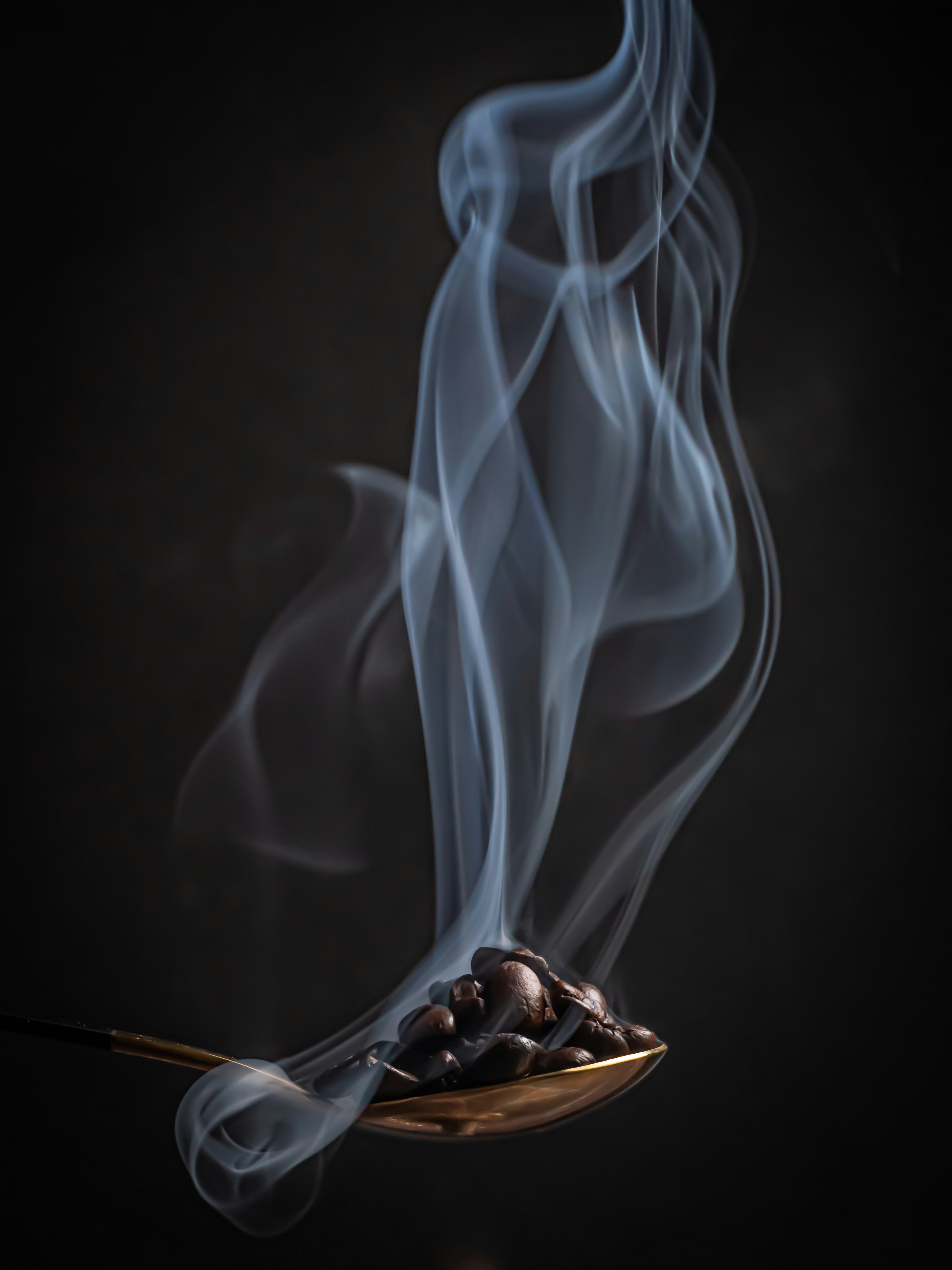 Steam Script: Coffee Beans on a Spoon Against Rising Wisps