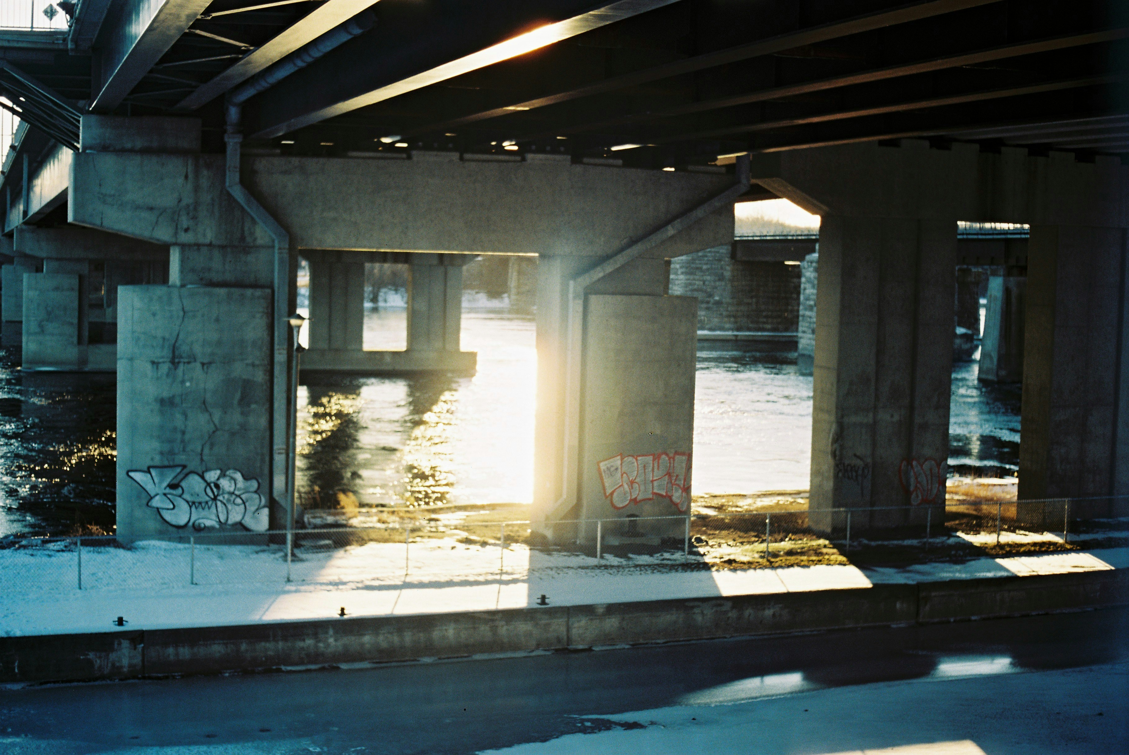 gray concrete bridge over body of water during daytime
