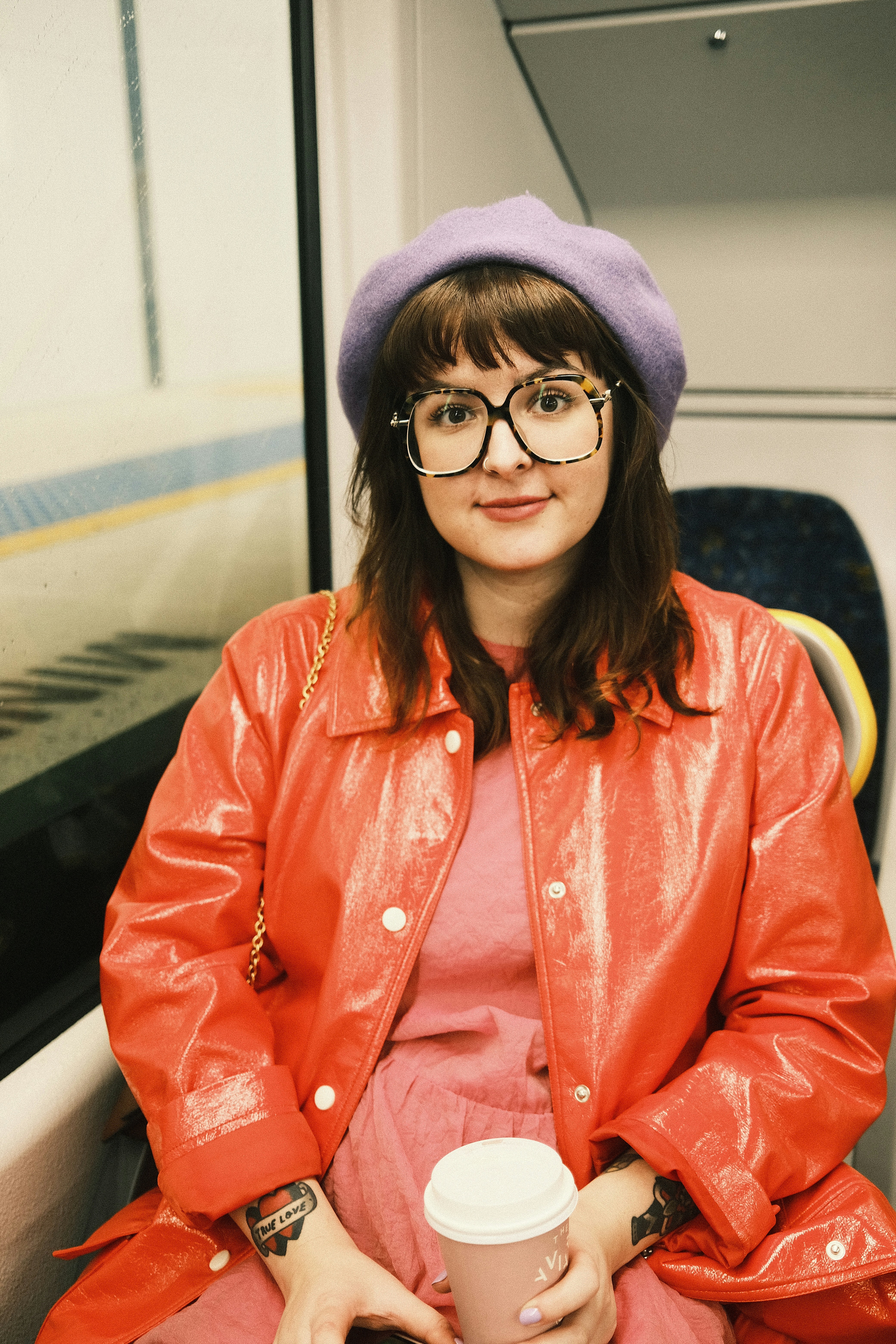 Velvet Beret Portrait: Neon-Red Jacket on a Subway