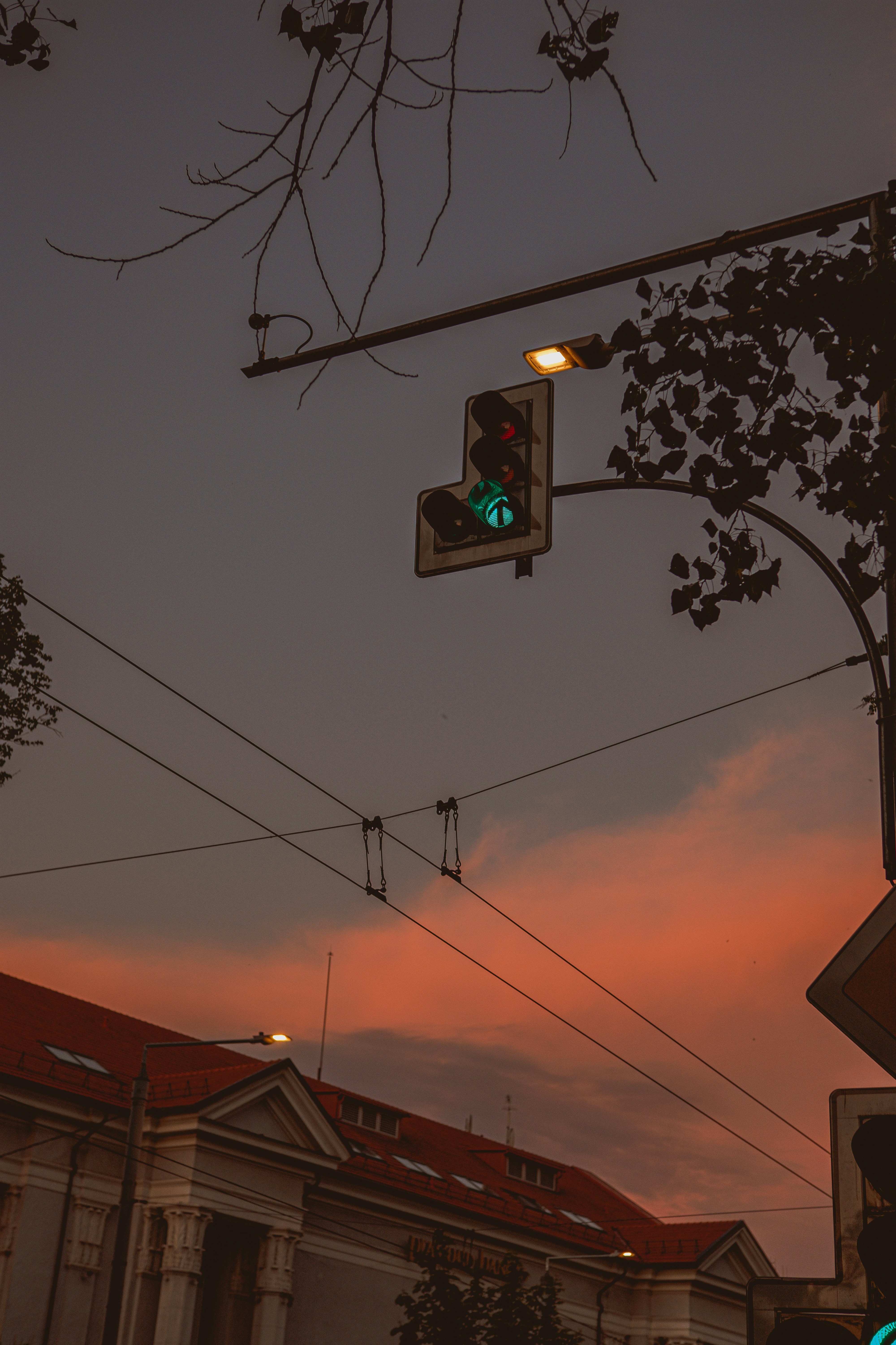 Emerald Traffic Light at Dusk Over a Historic Street