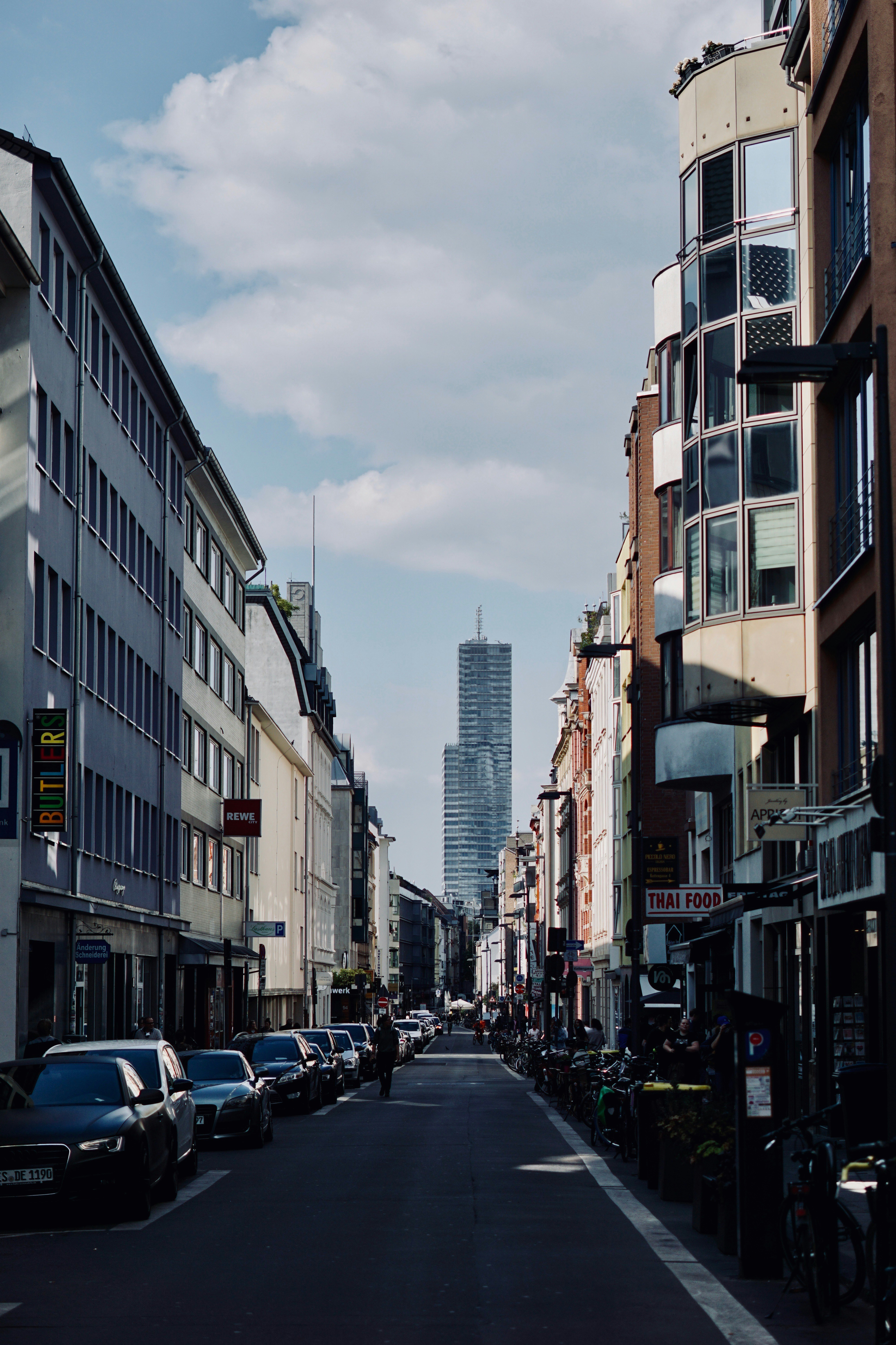 Vanishing Street Toward the Glass Spire: An Urban Portrait