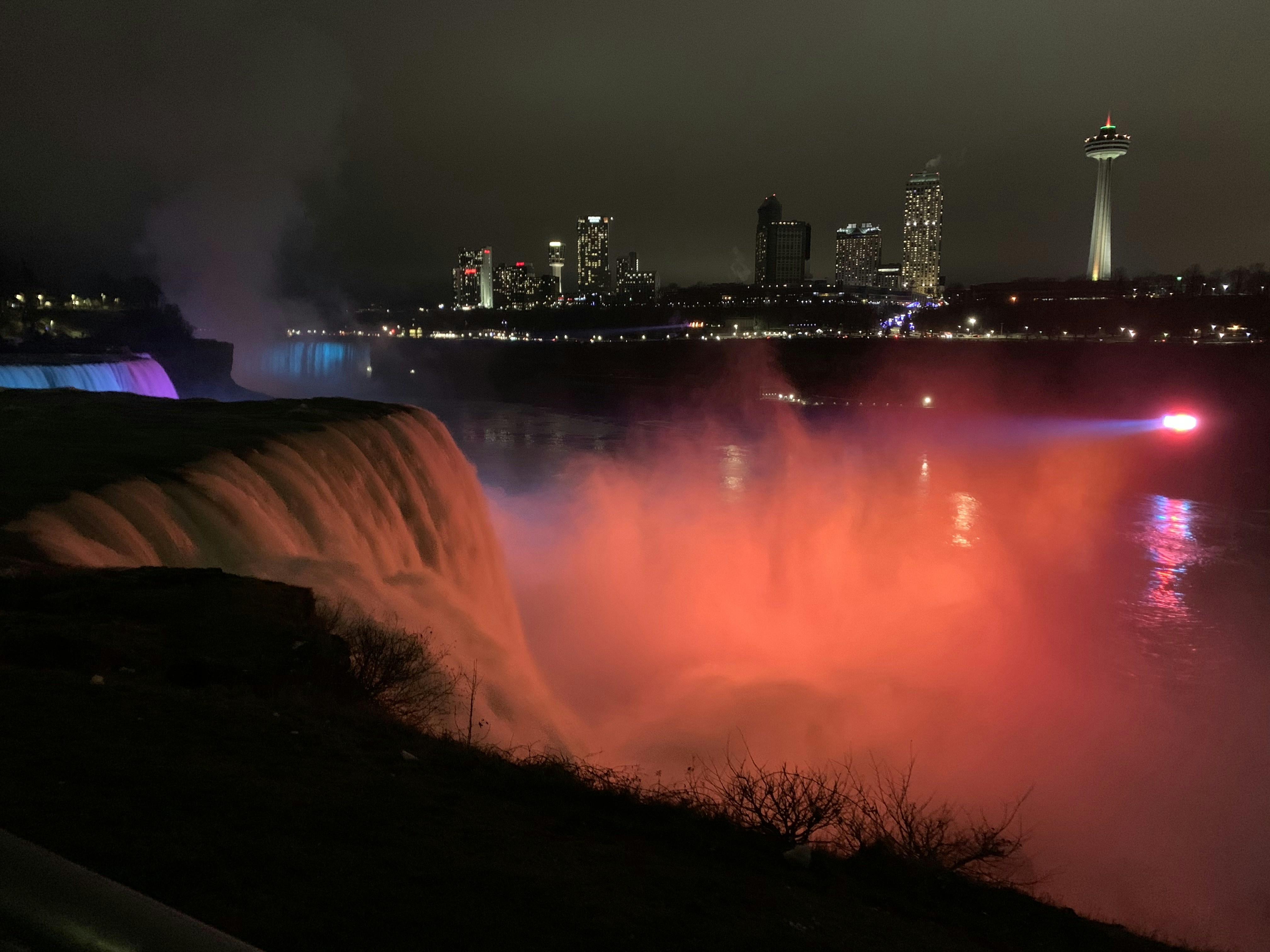 Water falls near city buildings during night time photo – Free Niagara ...