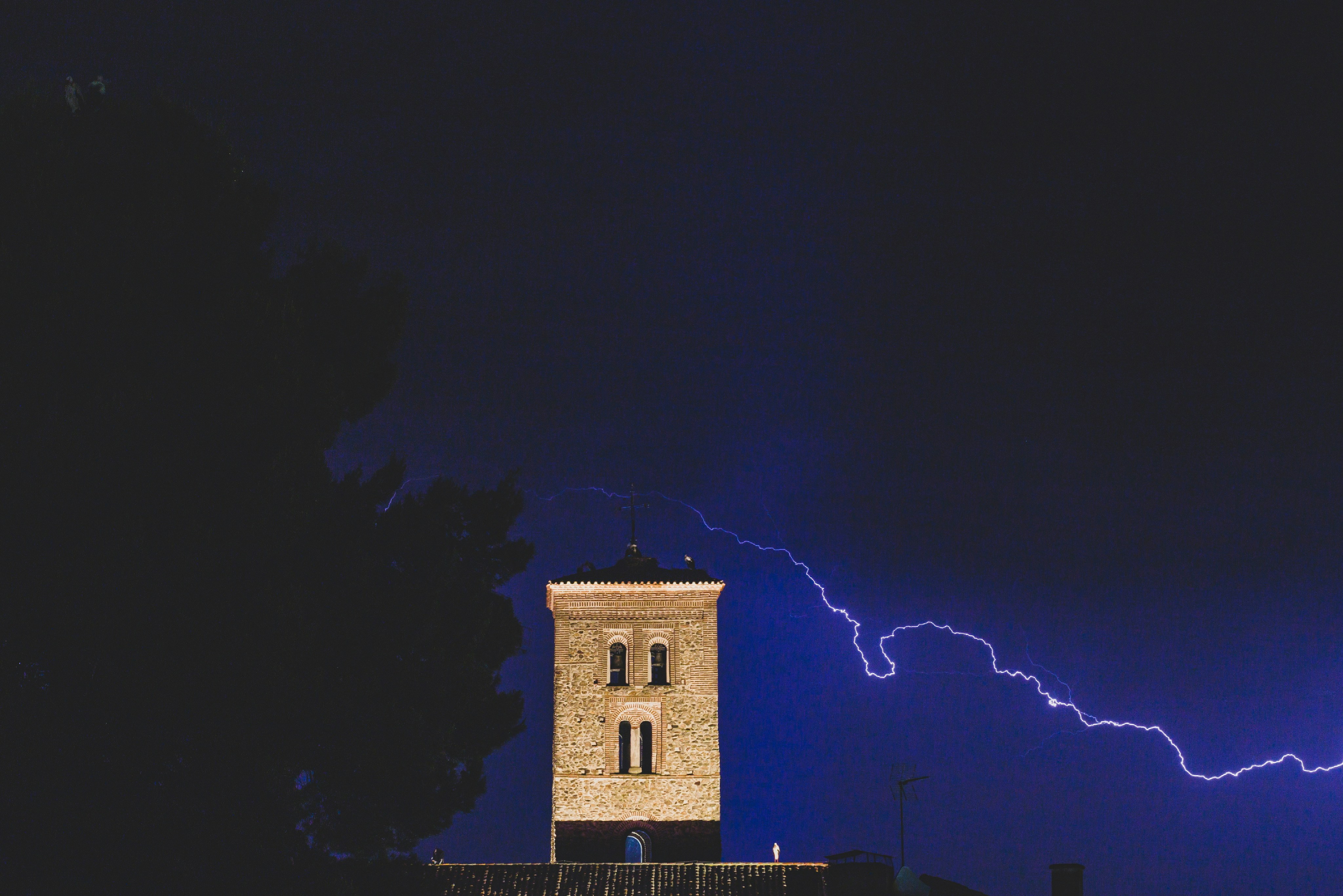 Electric Bell Tower under a Striking Thunderlit Sky