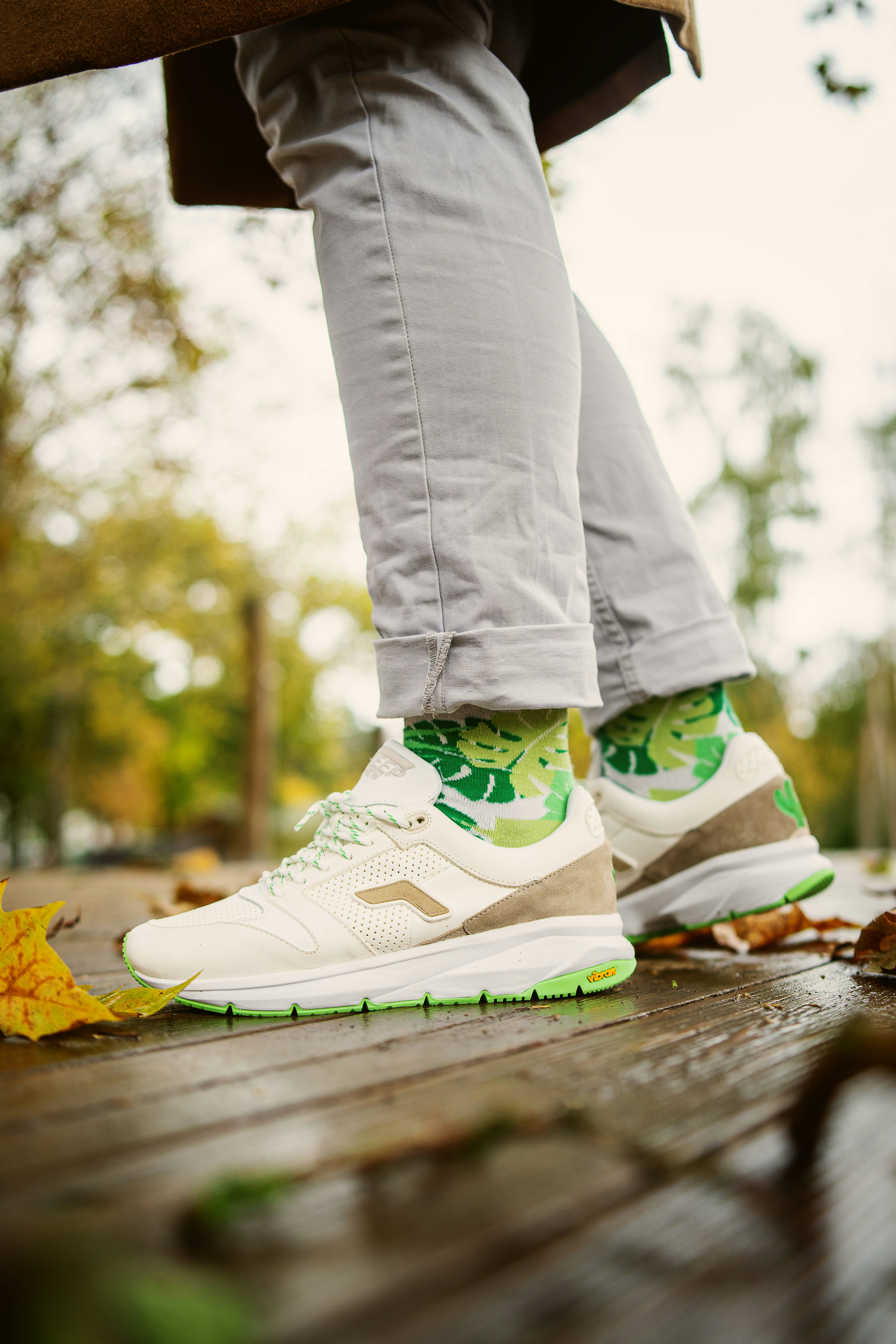 Step-Forward in Sneakers: Autumn Path and Ground-Level Focus