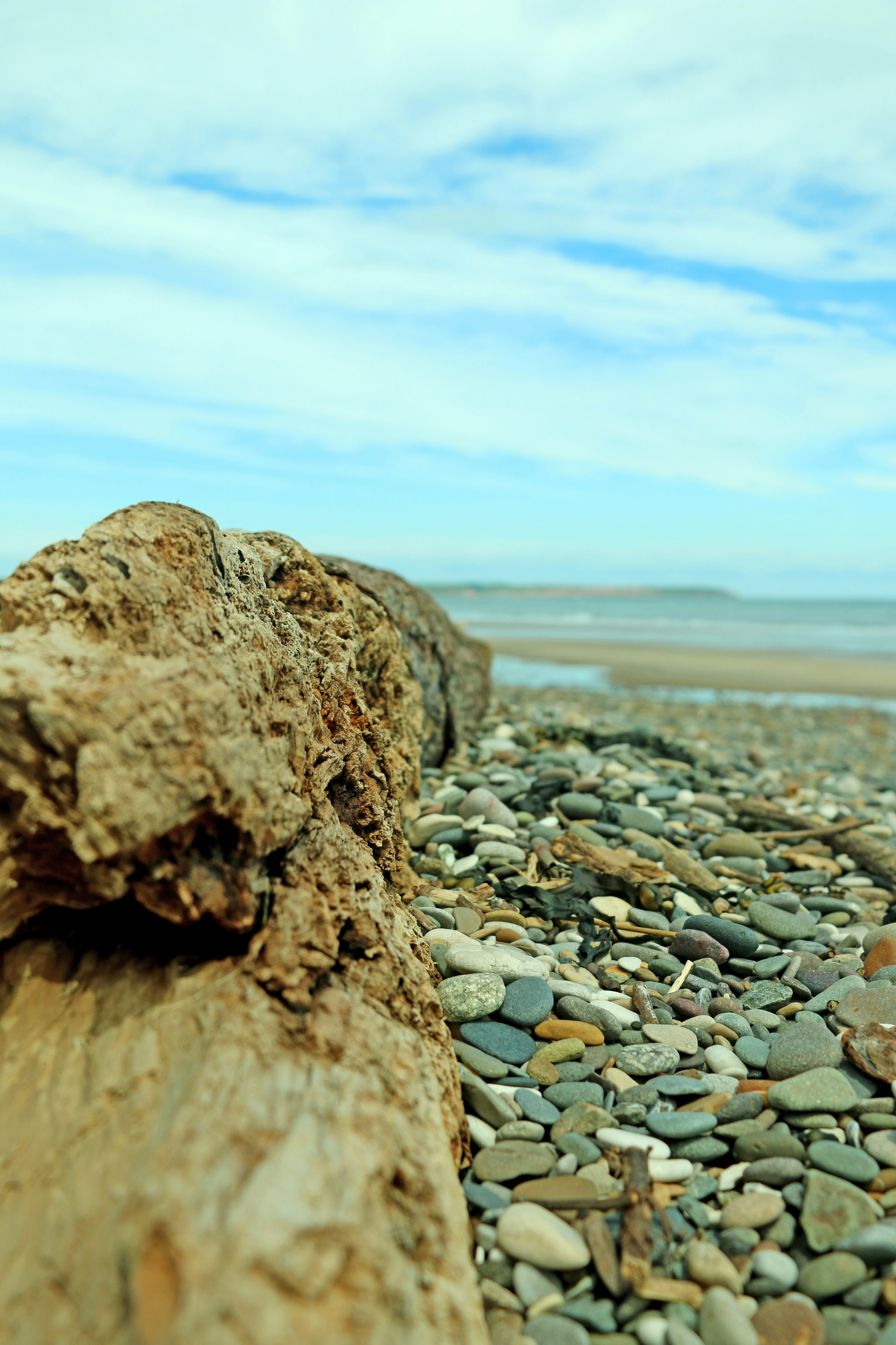 Granite Sentinel along a pebble shoreline