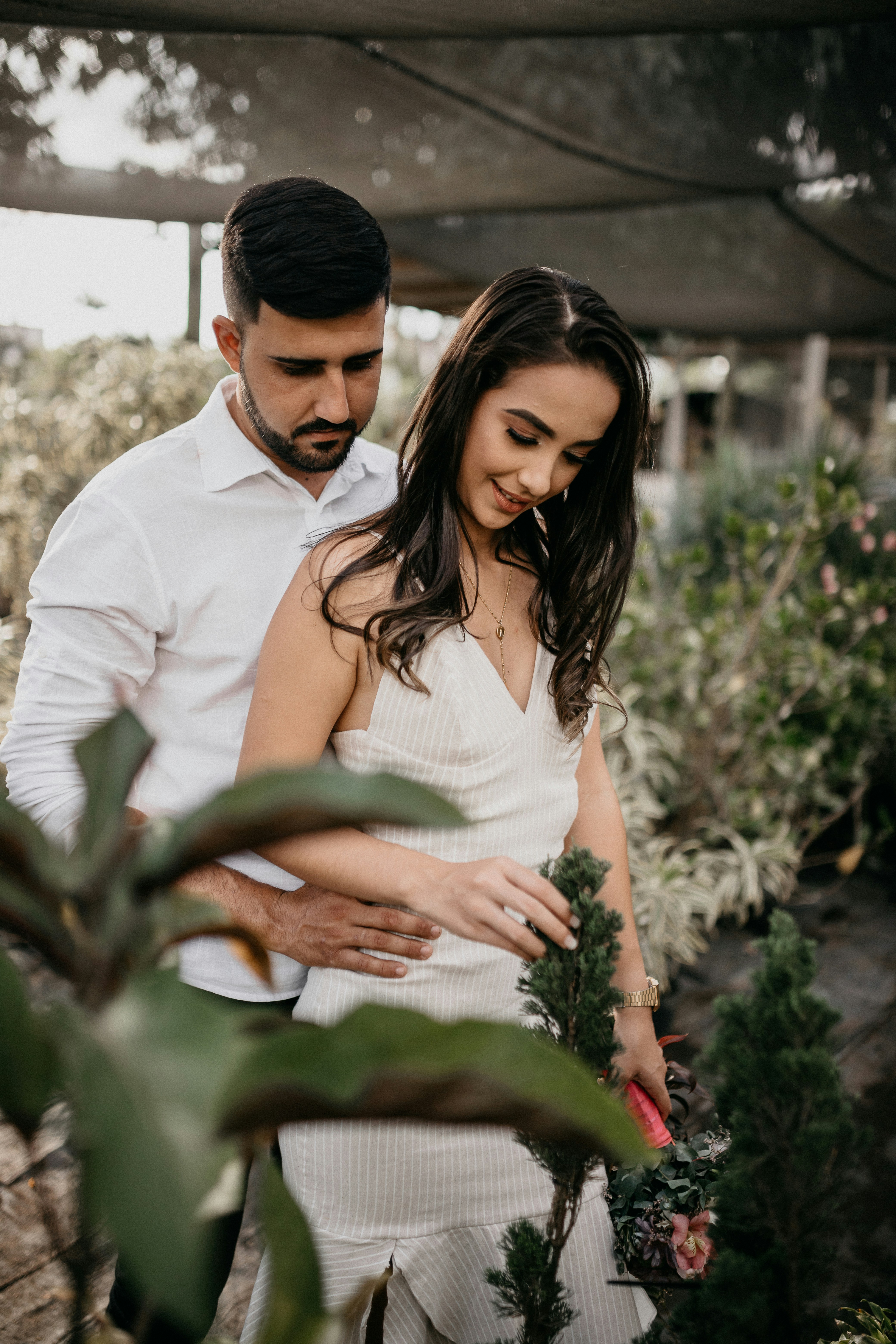 Garden Atrium Whisper: A Candid Moment of a Couple in White