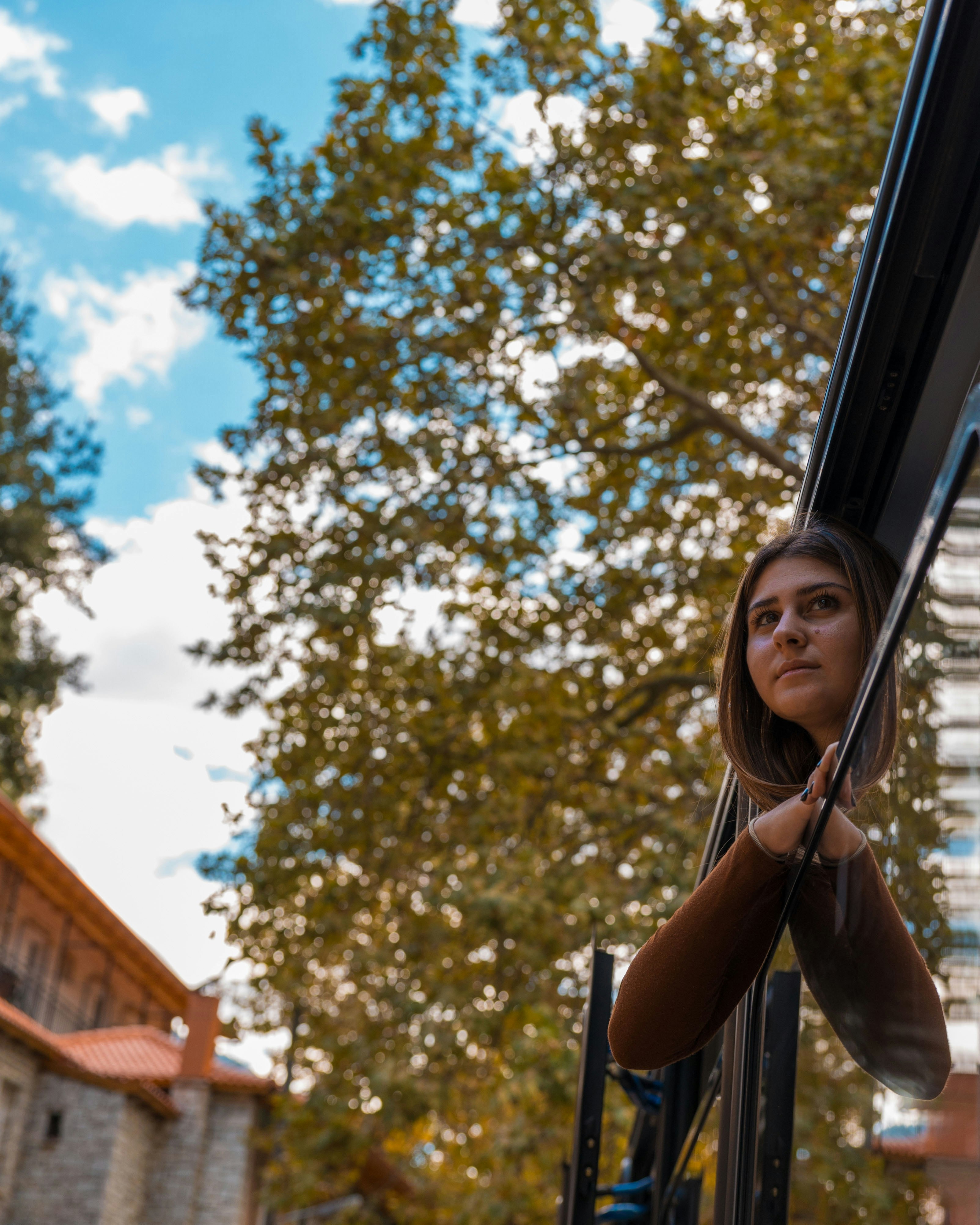 Woman in black tank top leaning on car window during daytime photo ...