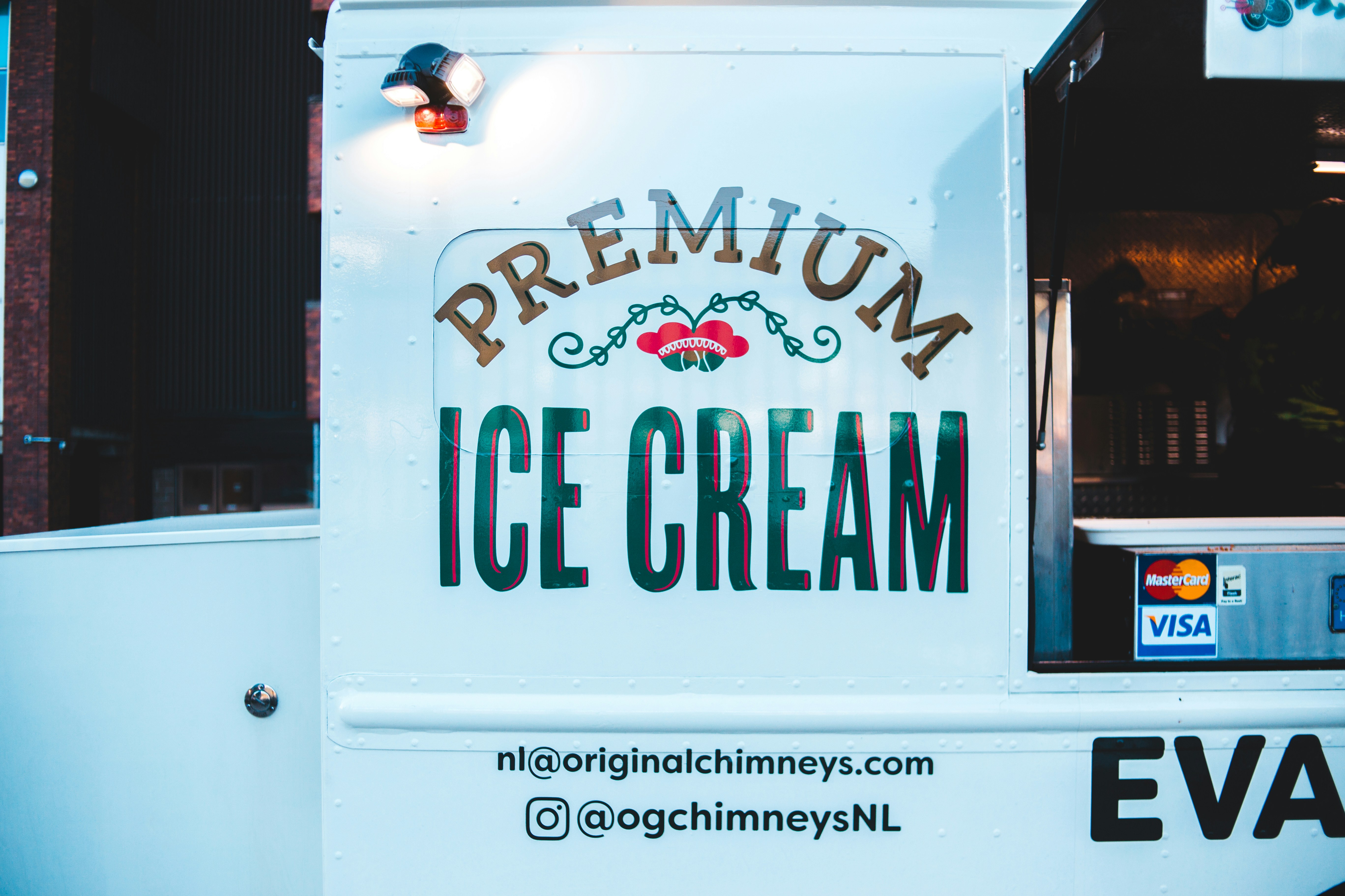 an ice cream truck parked in front of a building