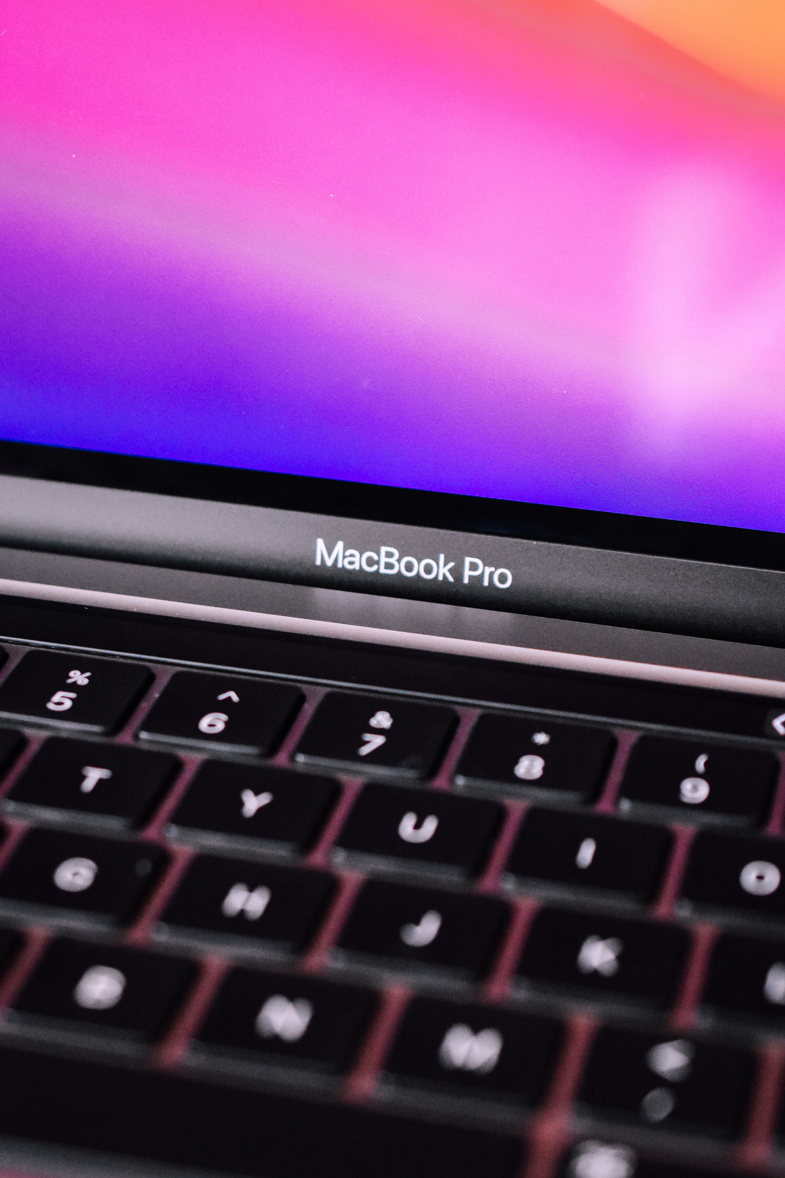 Neon Gradient Over a Quiet MacBook Pro Keyboard