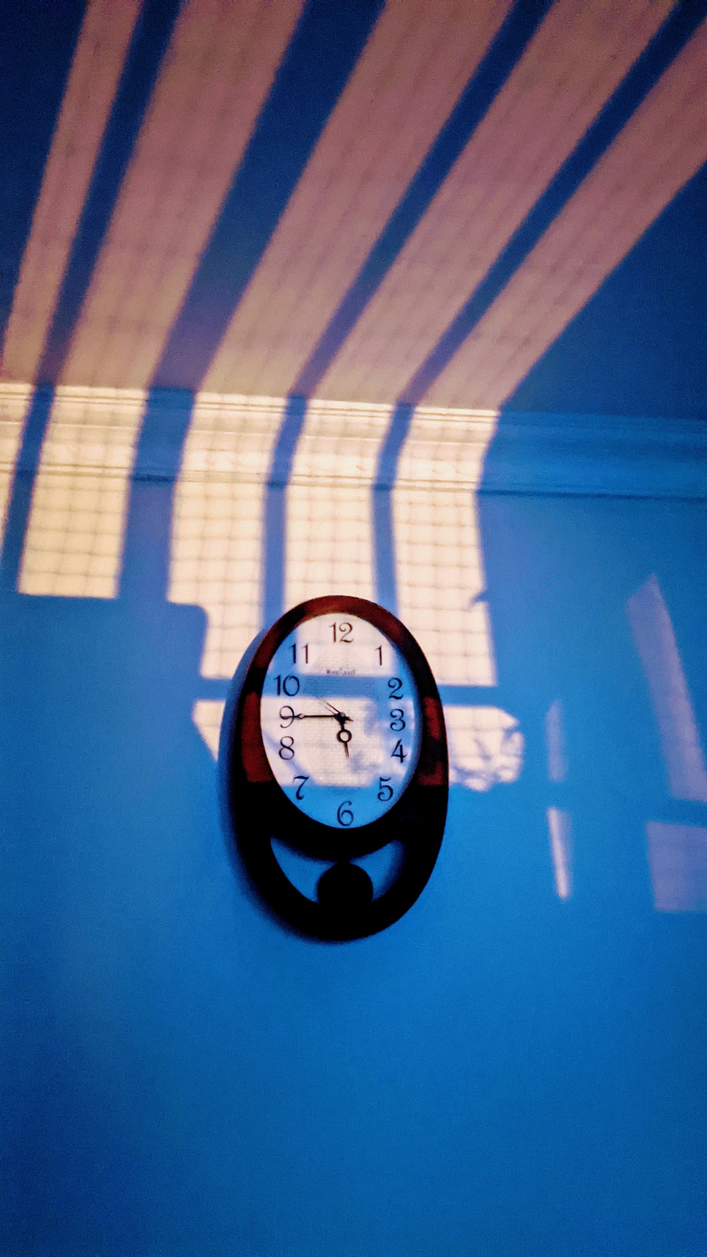 Blue Stripes and a Clock: Shadowed Light on a Wall