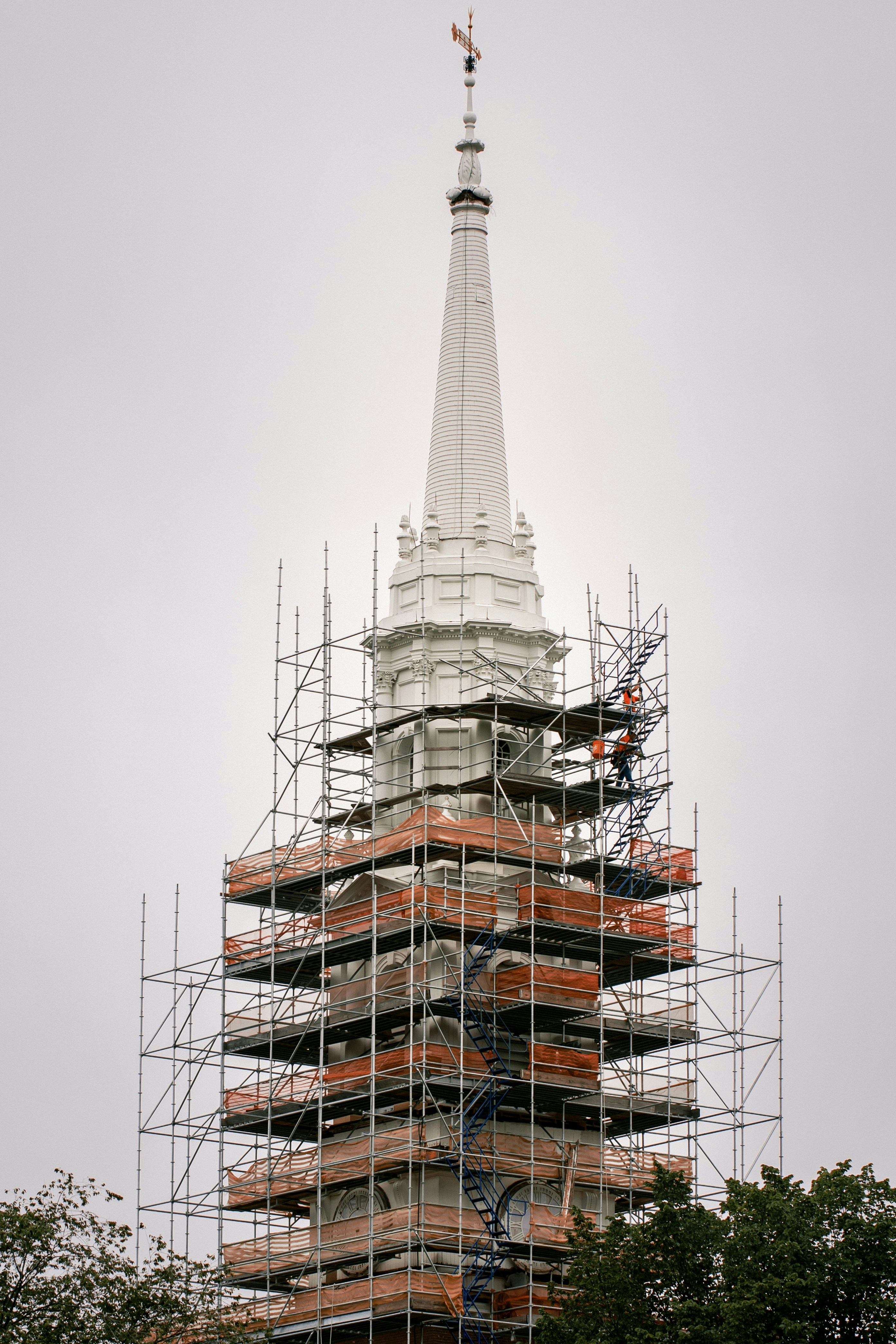 The Silent Summit: scaffolding cloaks a soaring spire