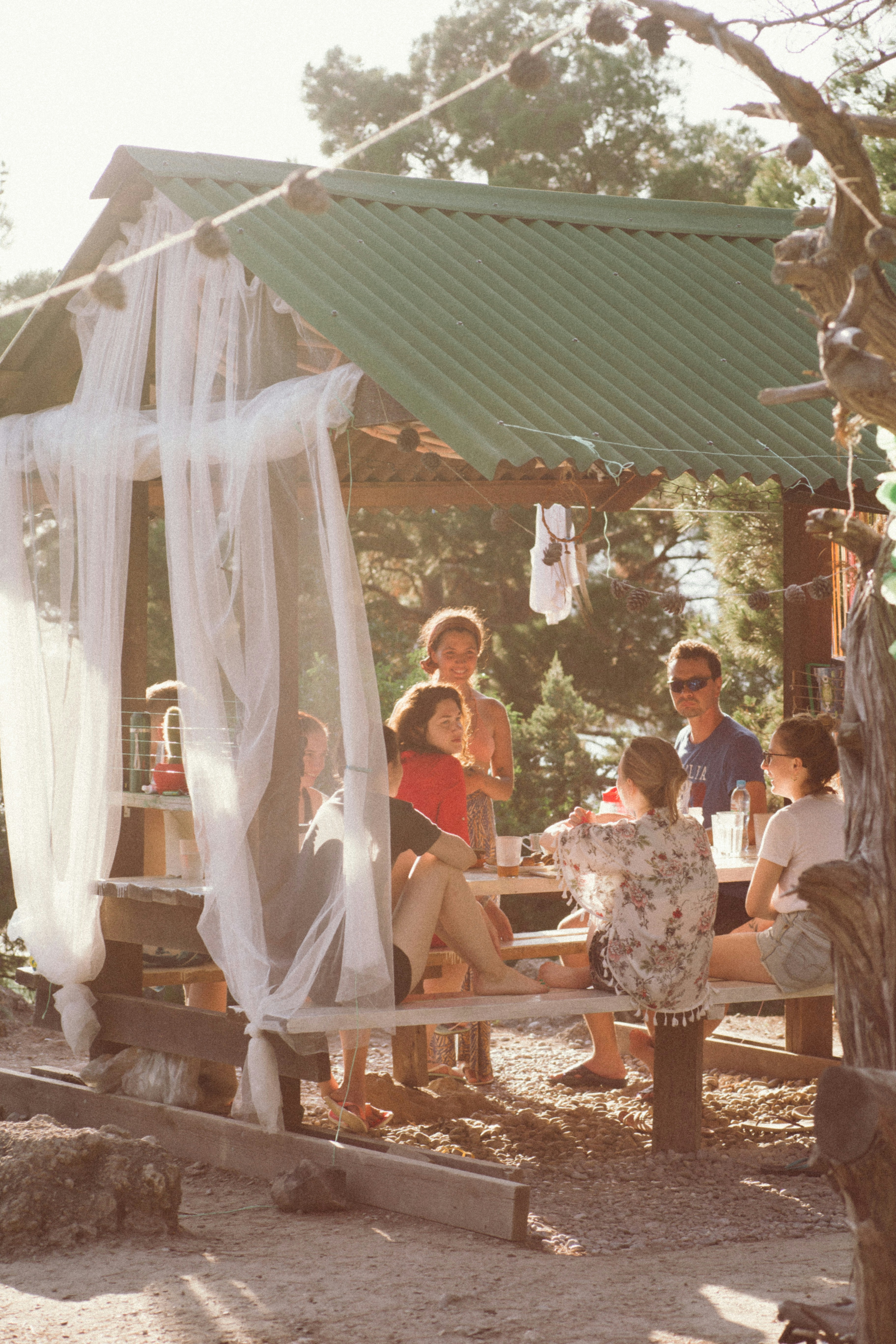 Sunlit Conversation Under a Rustic Corrugated Roof