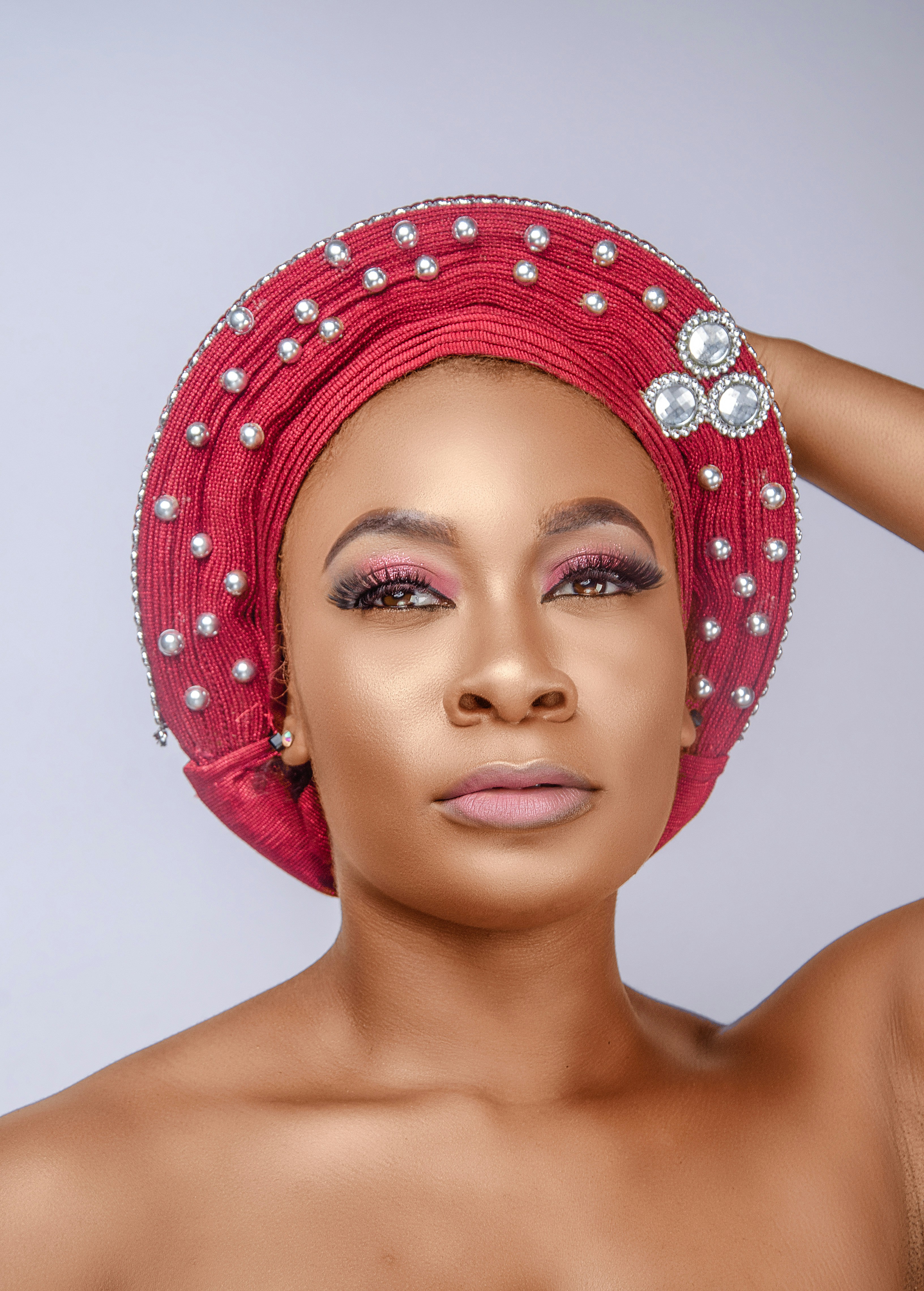 A woman wearing a red turban with pearls on it photo – Free African ...