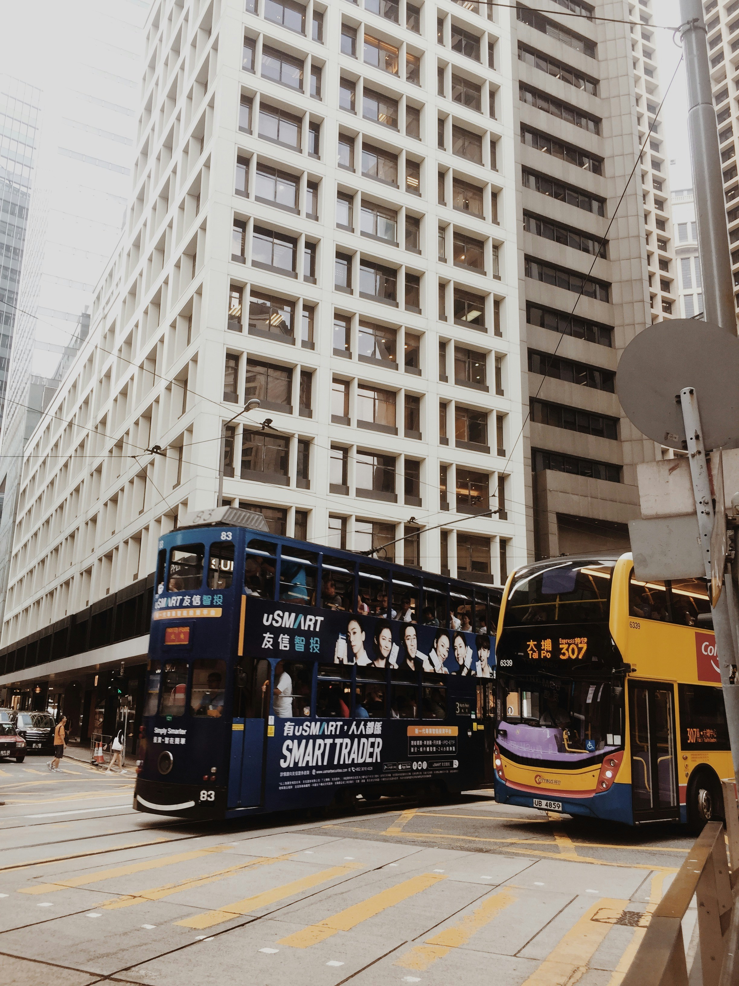 Blue Double-Decker Glide Through a Glass Canyon