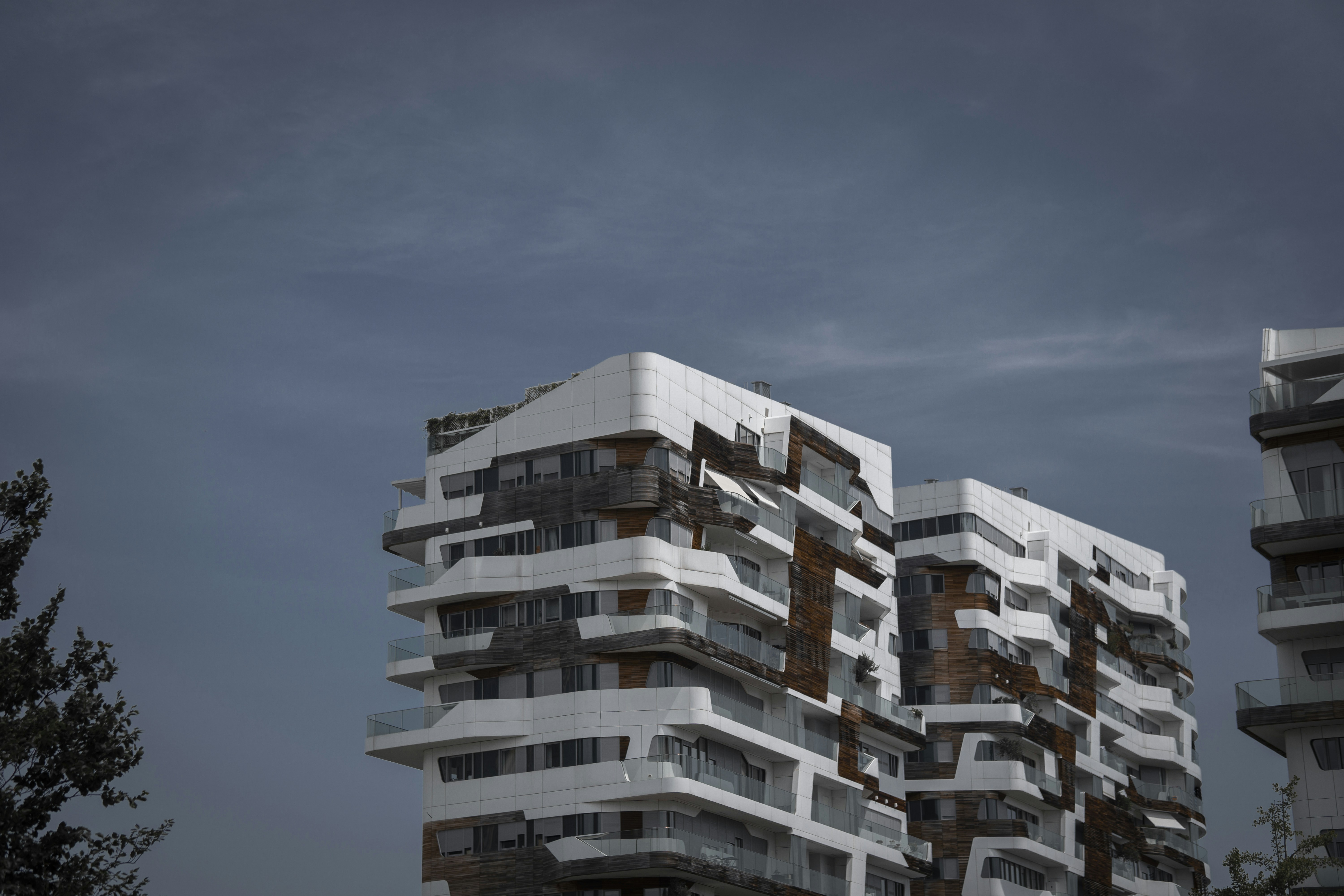 Tiered White Balconies: A Modernist Apartment Block Against a Clear Sky