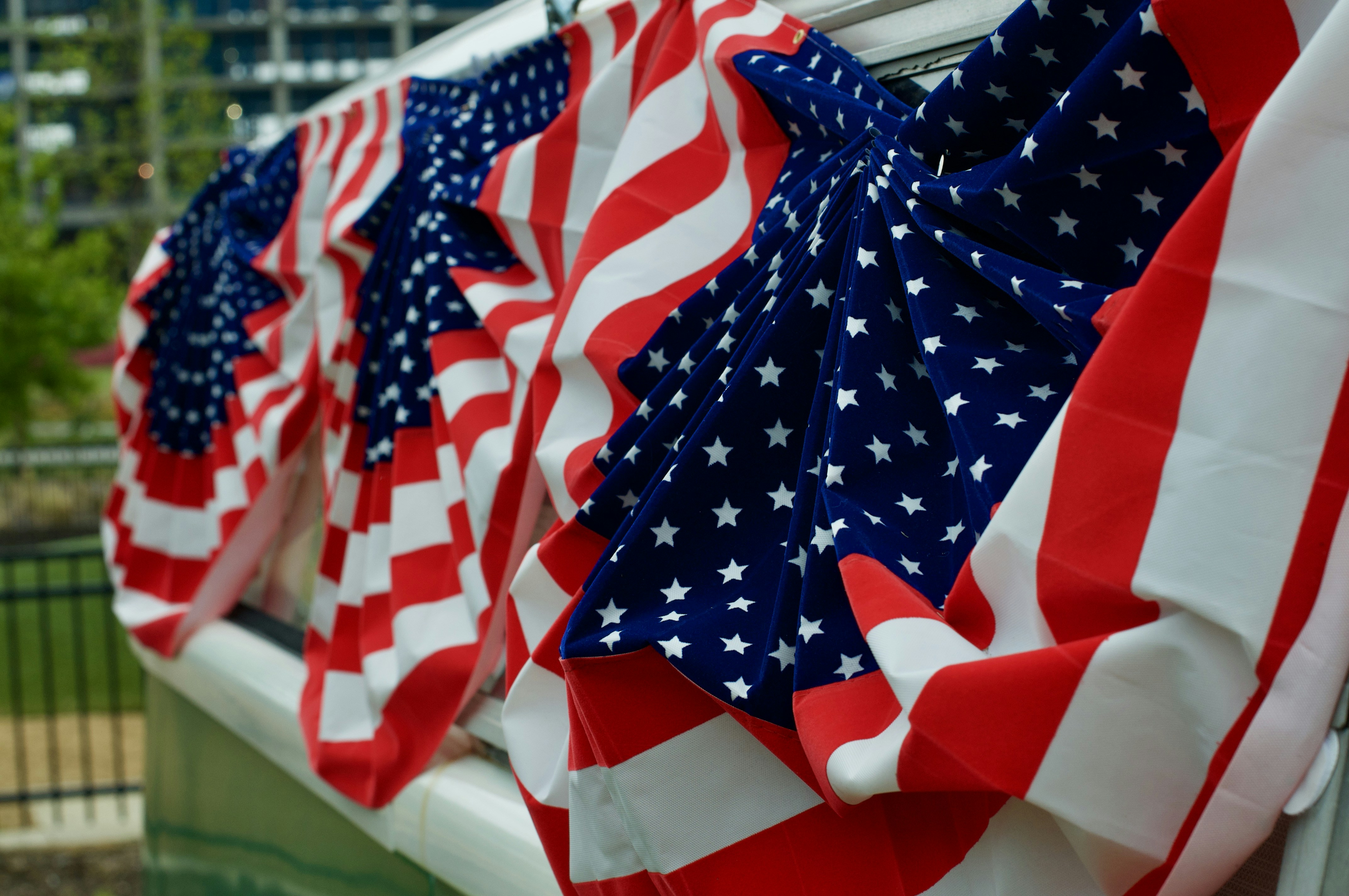 Ribbons of Red, White, and Blue Draped Along a Park Railing