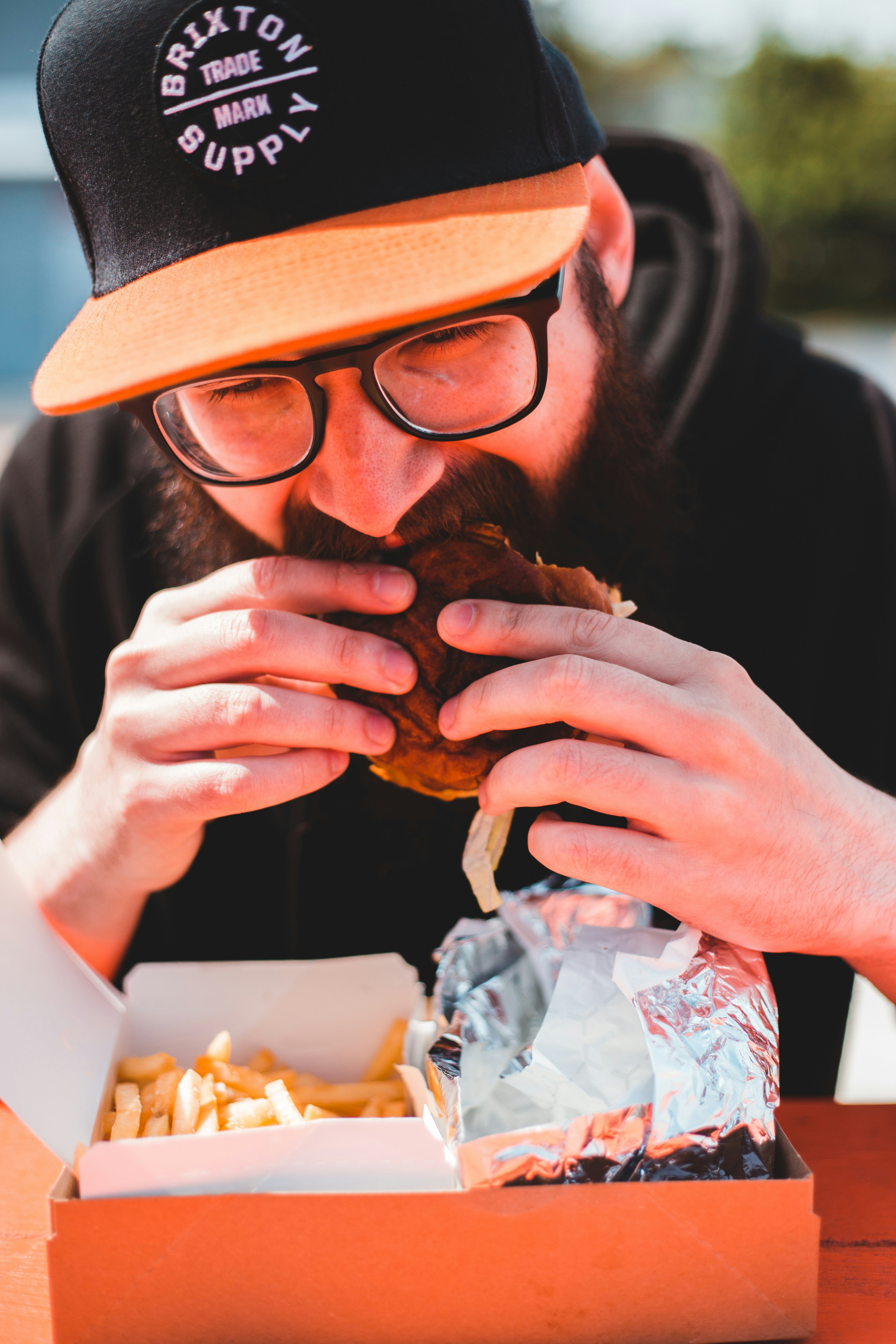 Beard, Brixton, and a Burger: A Sunlit Outdoor Snack Moment