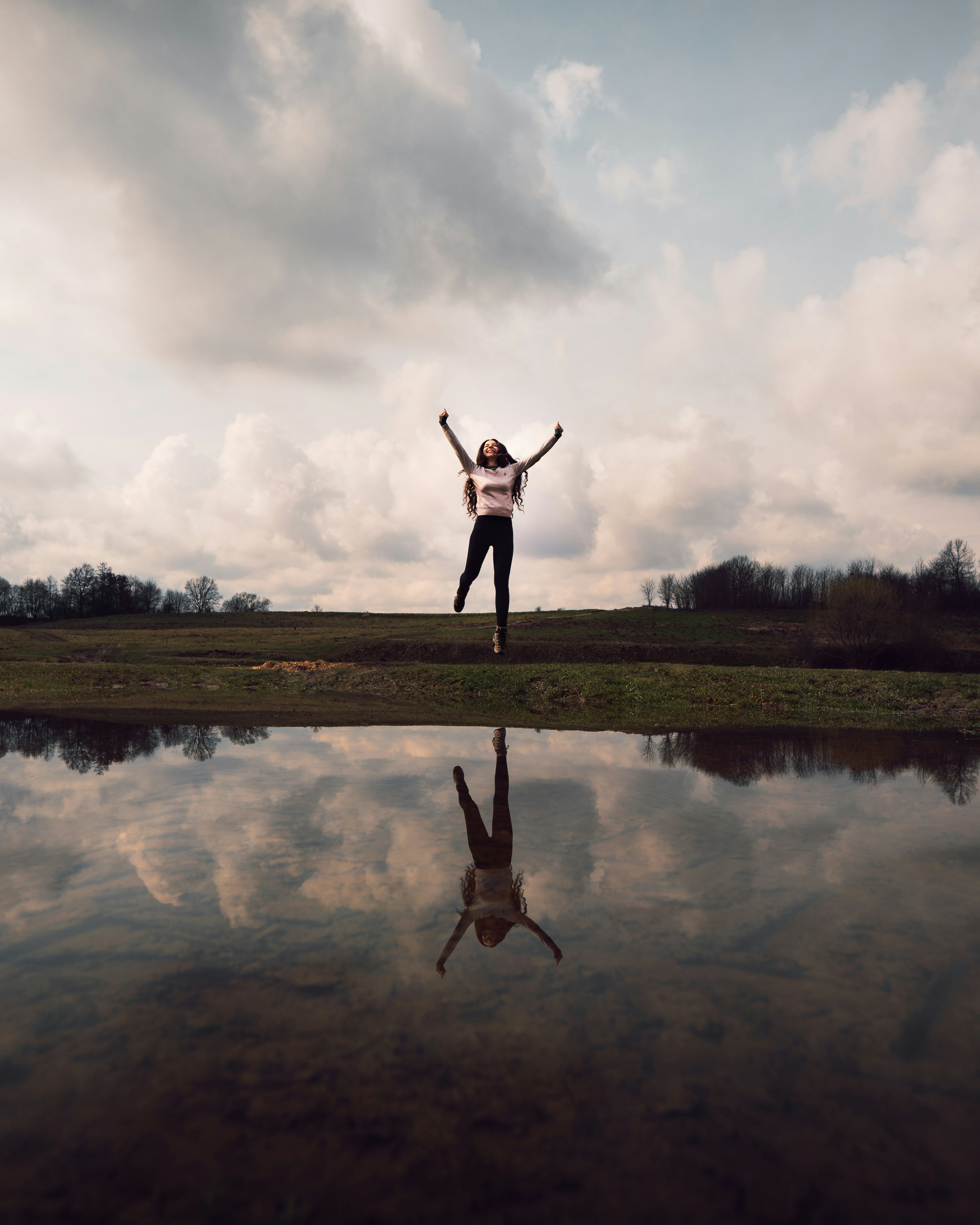 Person standing on grass field near lake during daytime photo – Free ...