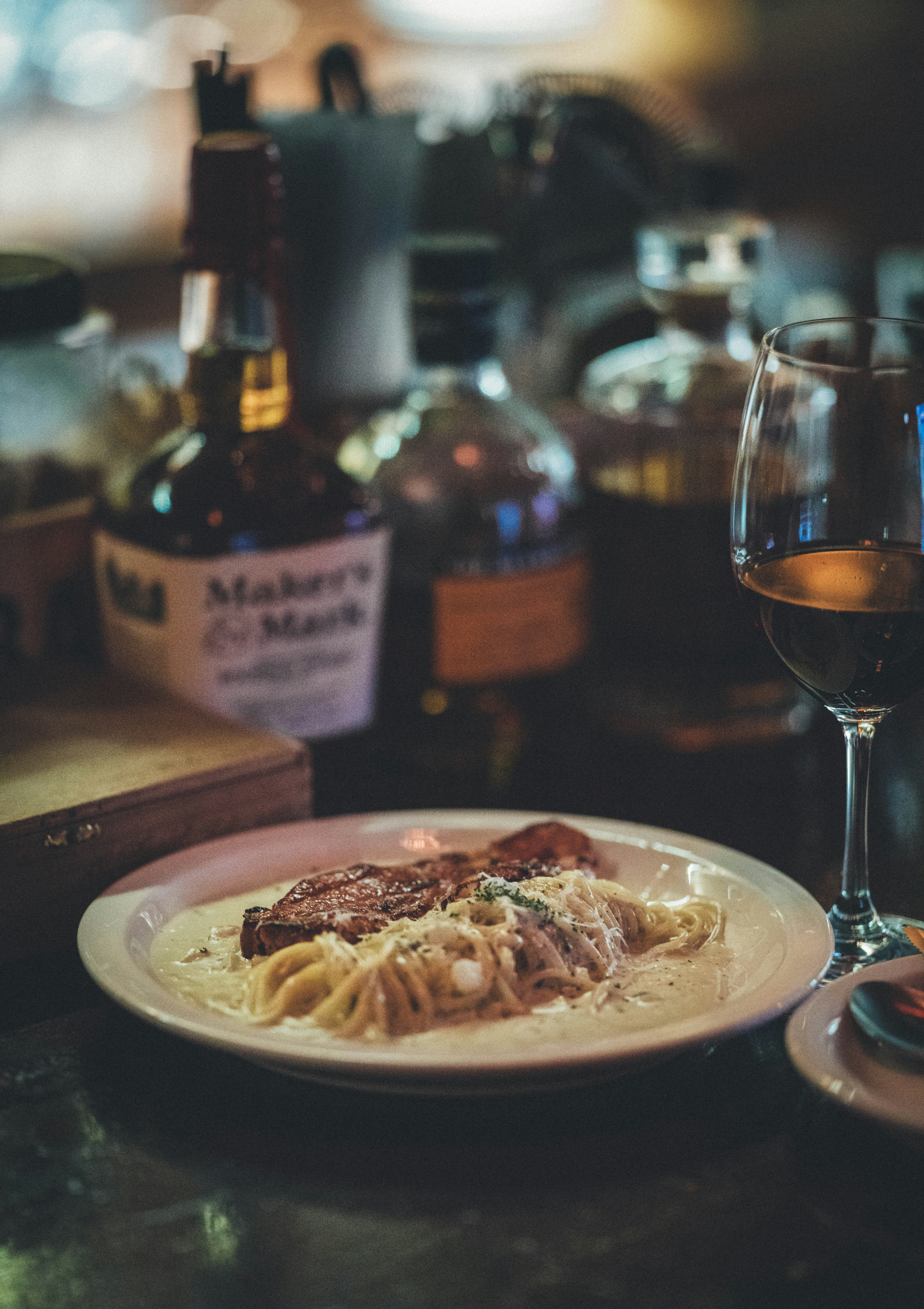 Luminous Plate: Pasta and Palette of Glass in a Dim Bar
