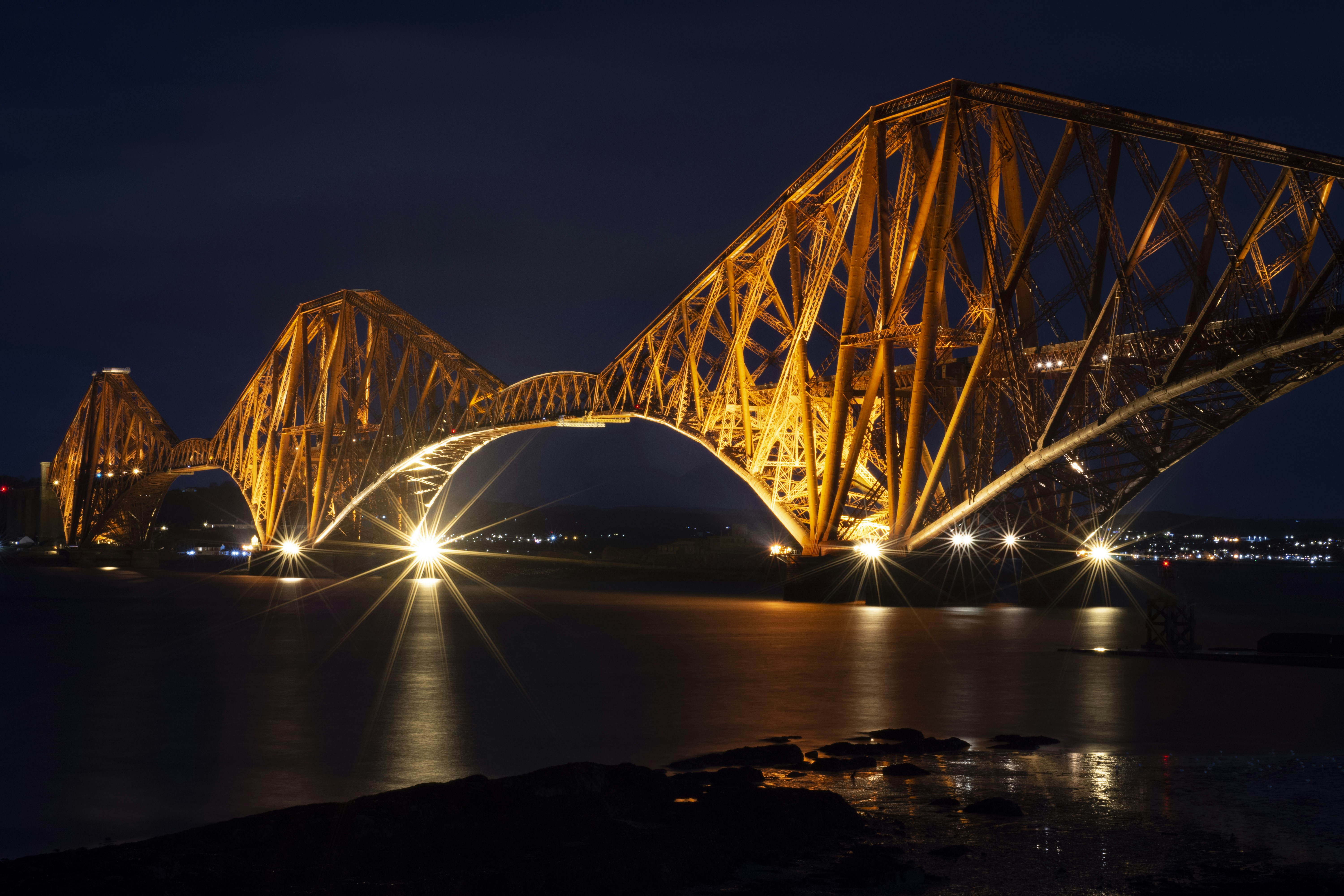 Amber Lattices Over Quiet Water: Night Bridge Portrait