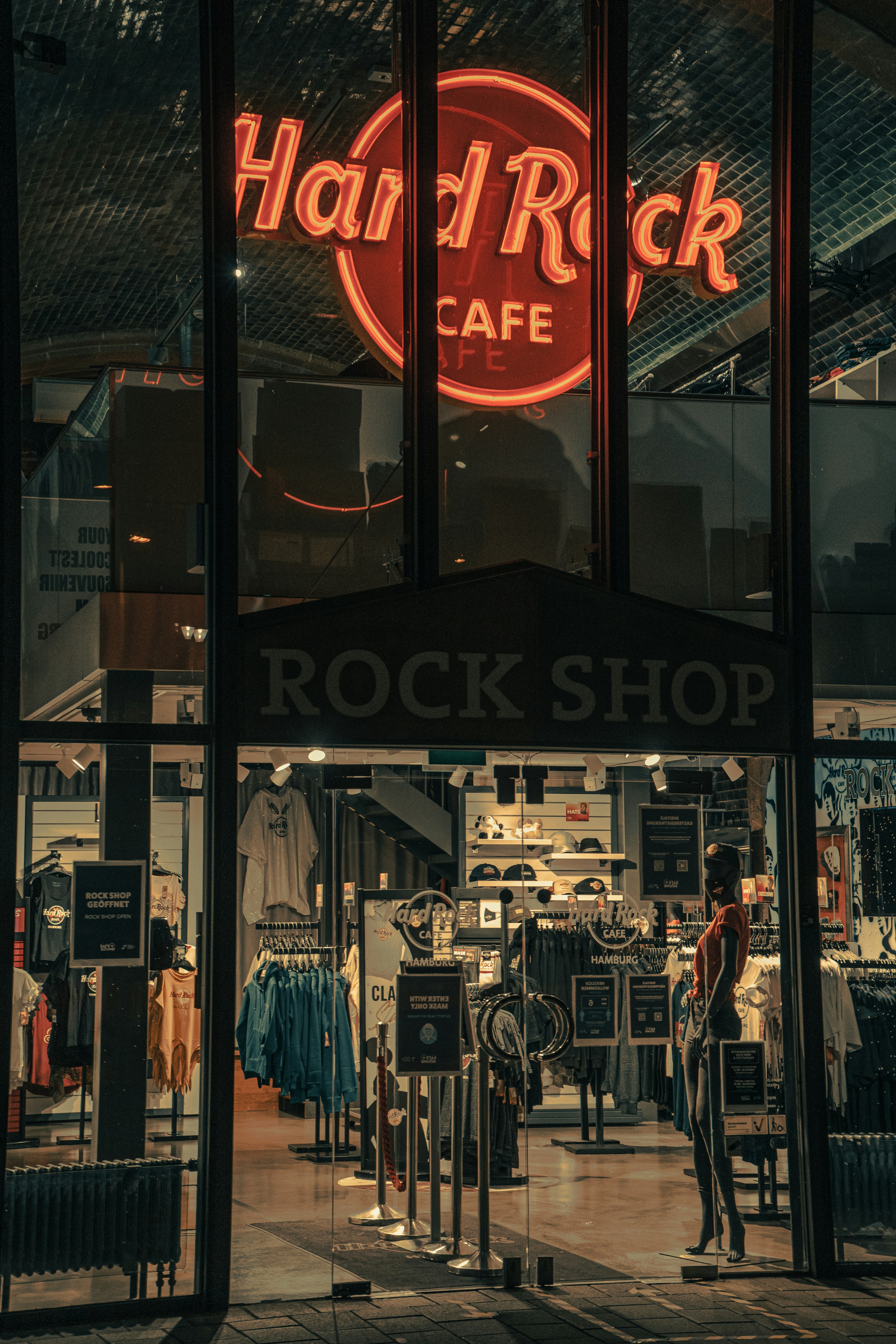 Neon Halo Over Glass: Nighttime View Into the Hard Rock Café Rock Shop