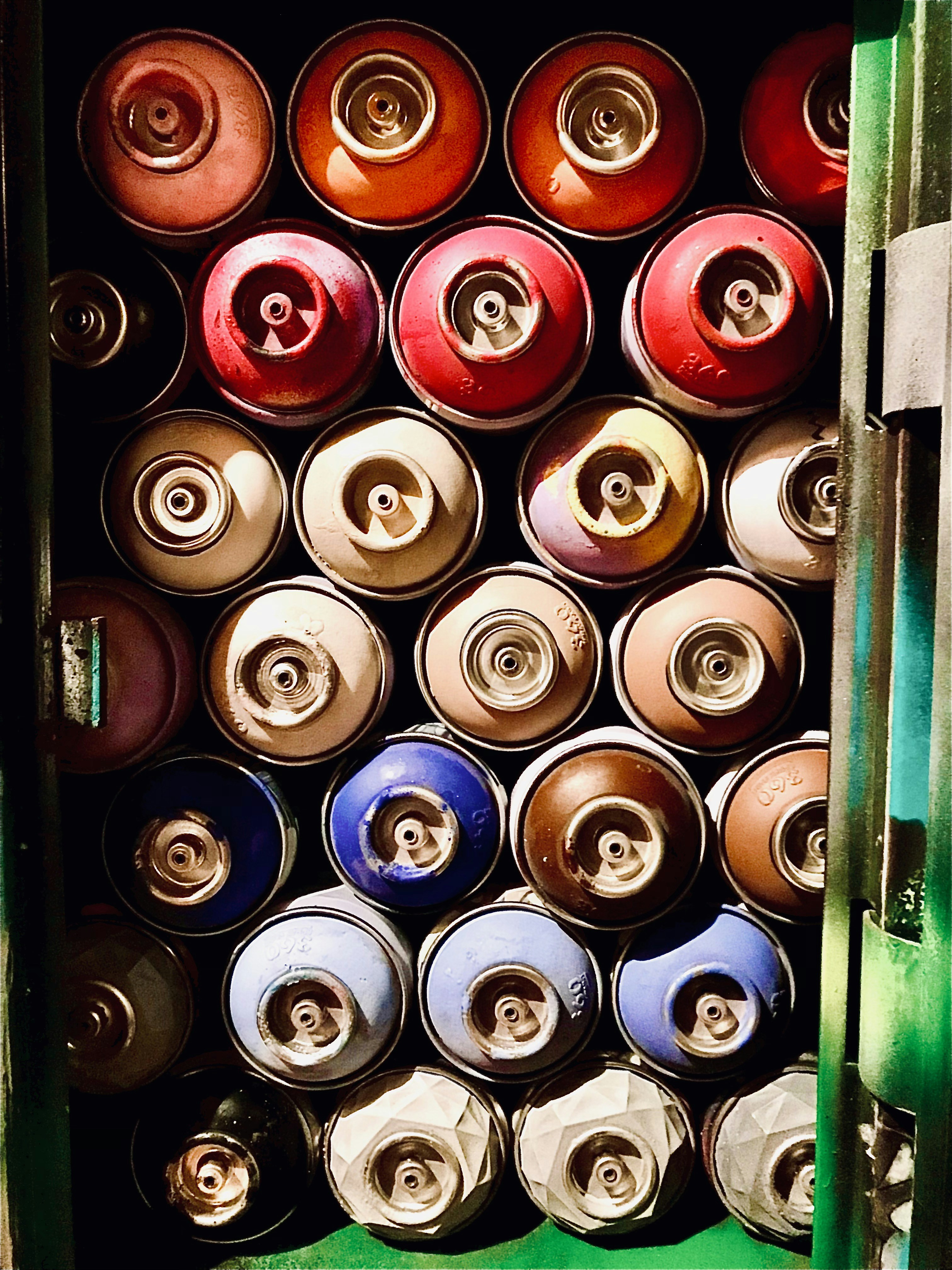Rainbow Stacks: A Close-Up of Cans in a Narrow Crate