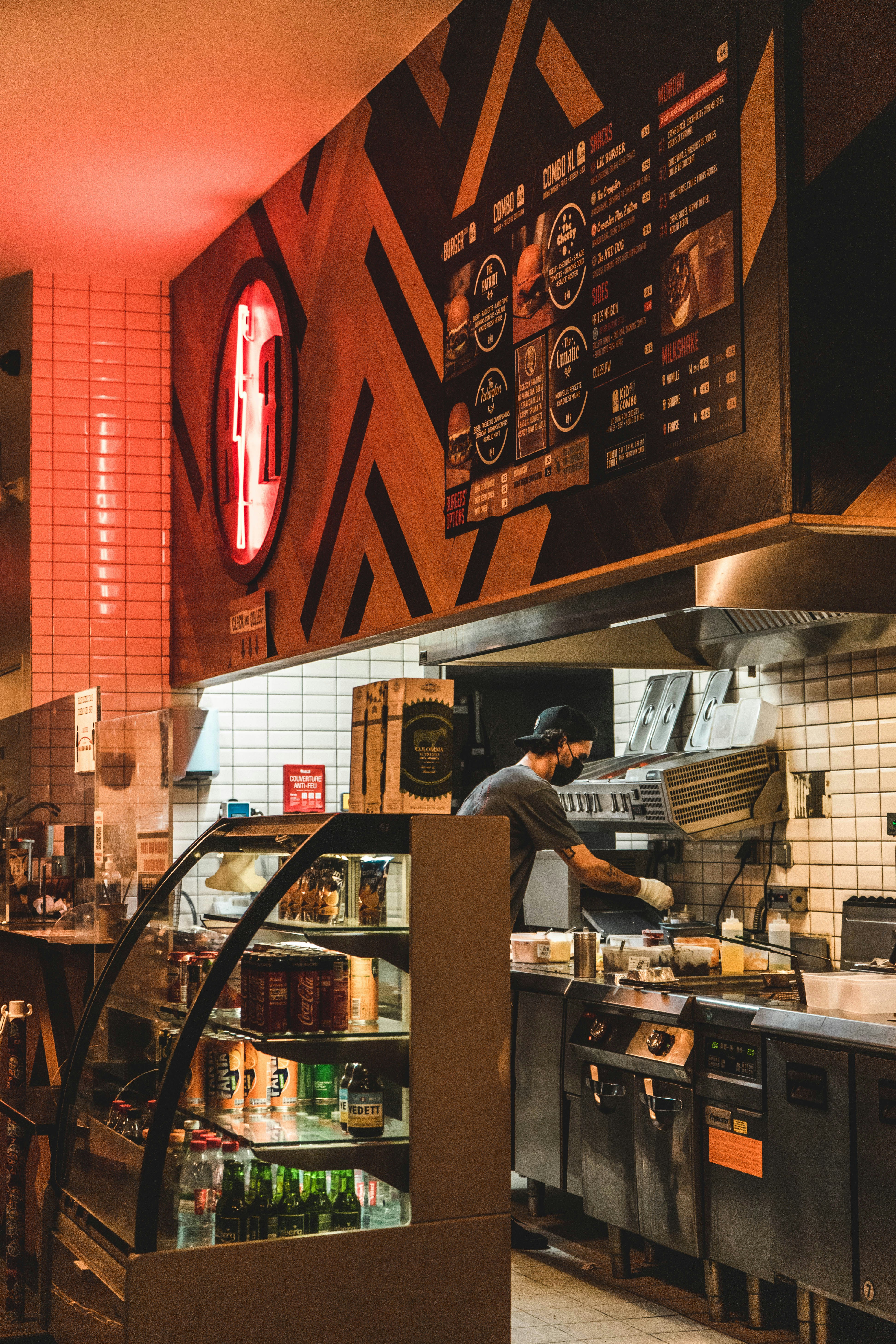 Man in black t-shirt standing in front of store photo – Free The roster ...
