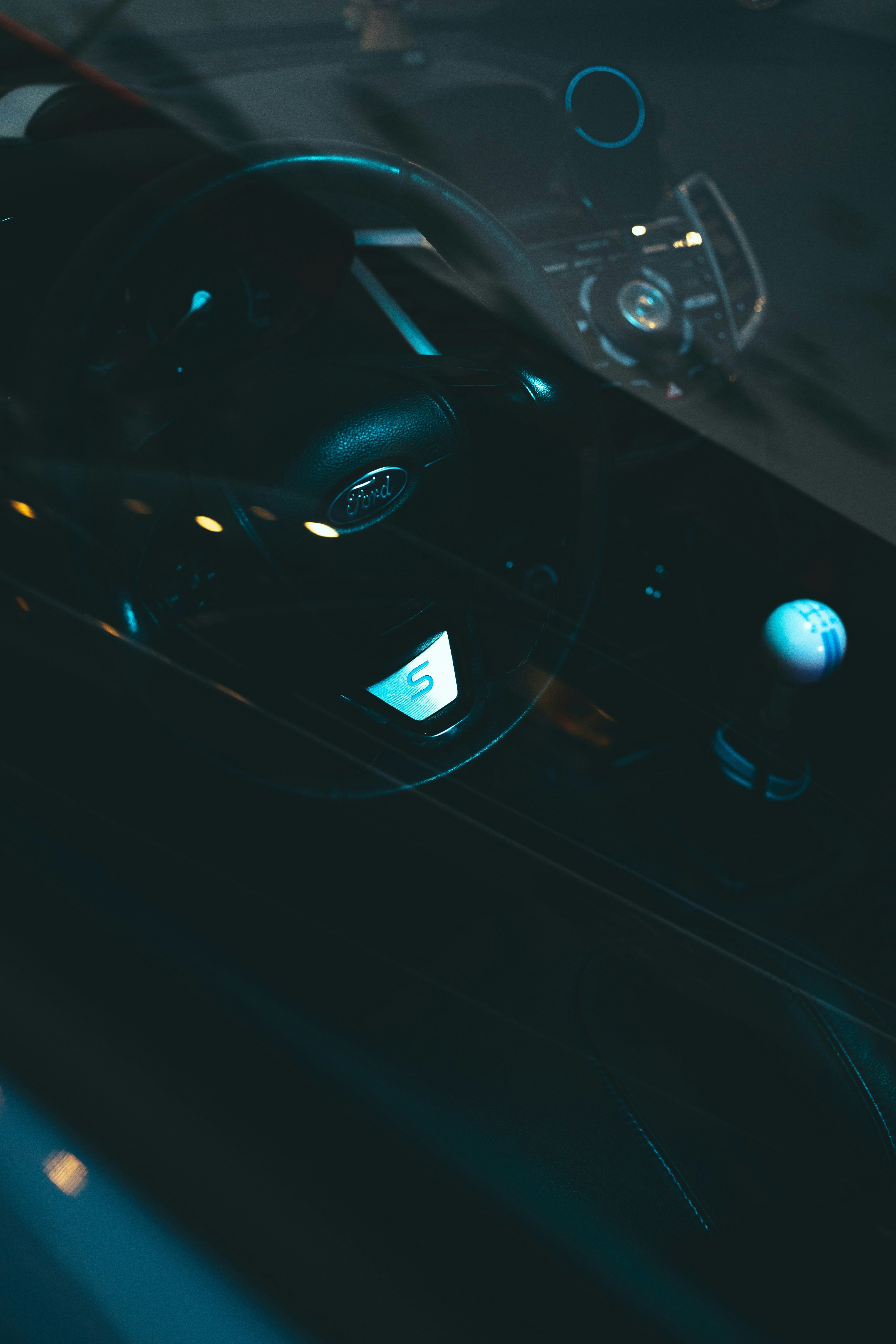 Cobalt Glow Inside a Midnight Cockpit: A Close-Up of a Sporty Car’s Interior
